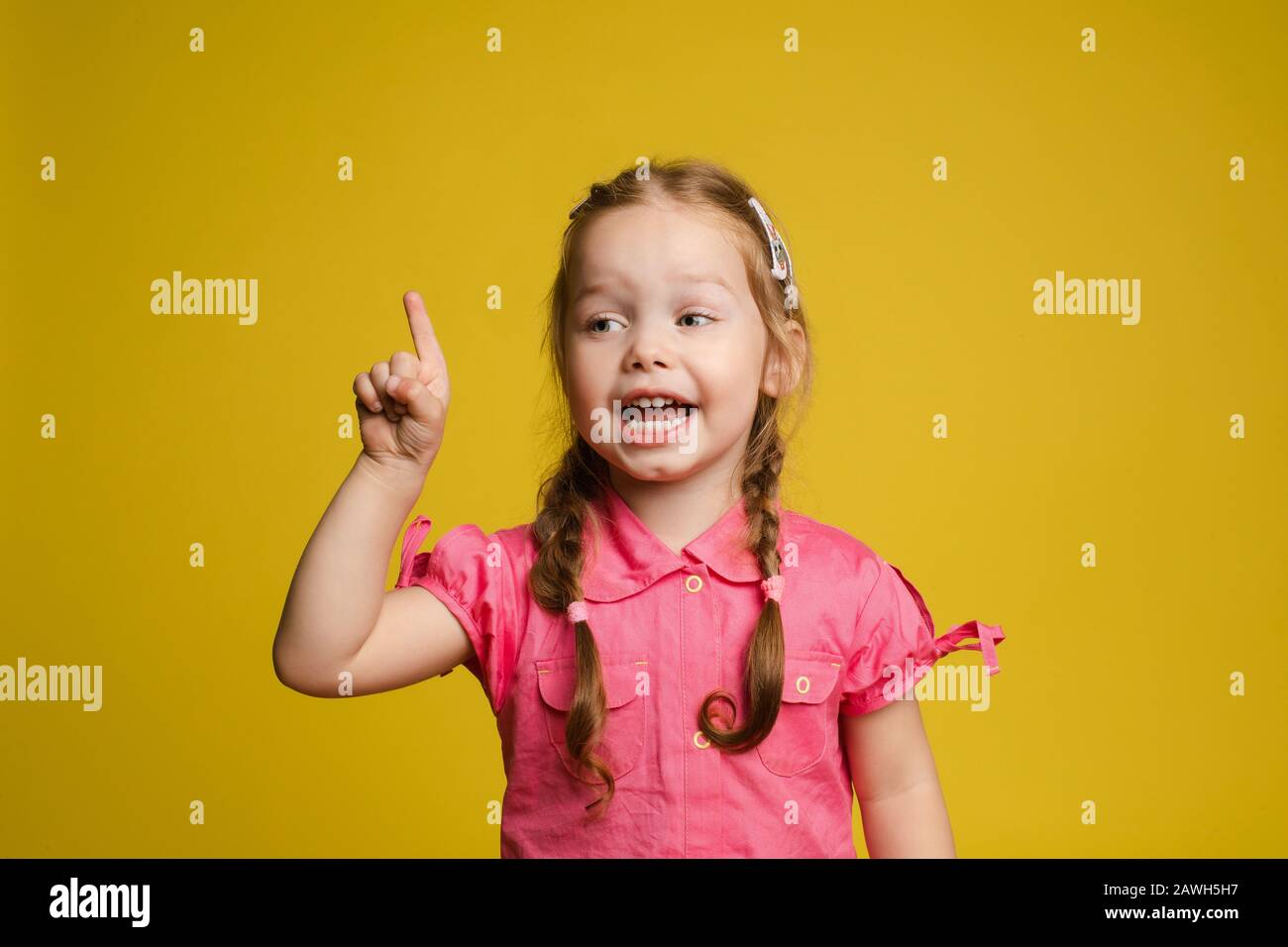Little girl in dress and sunglasses indicating the direction Stock ...