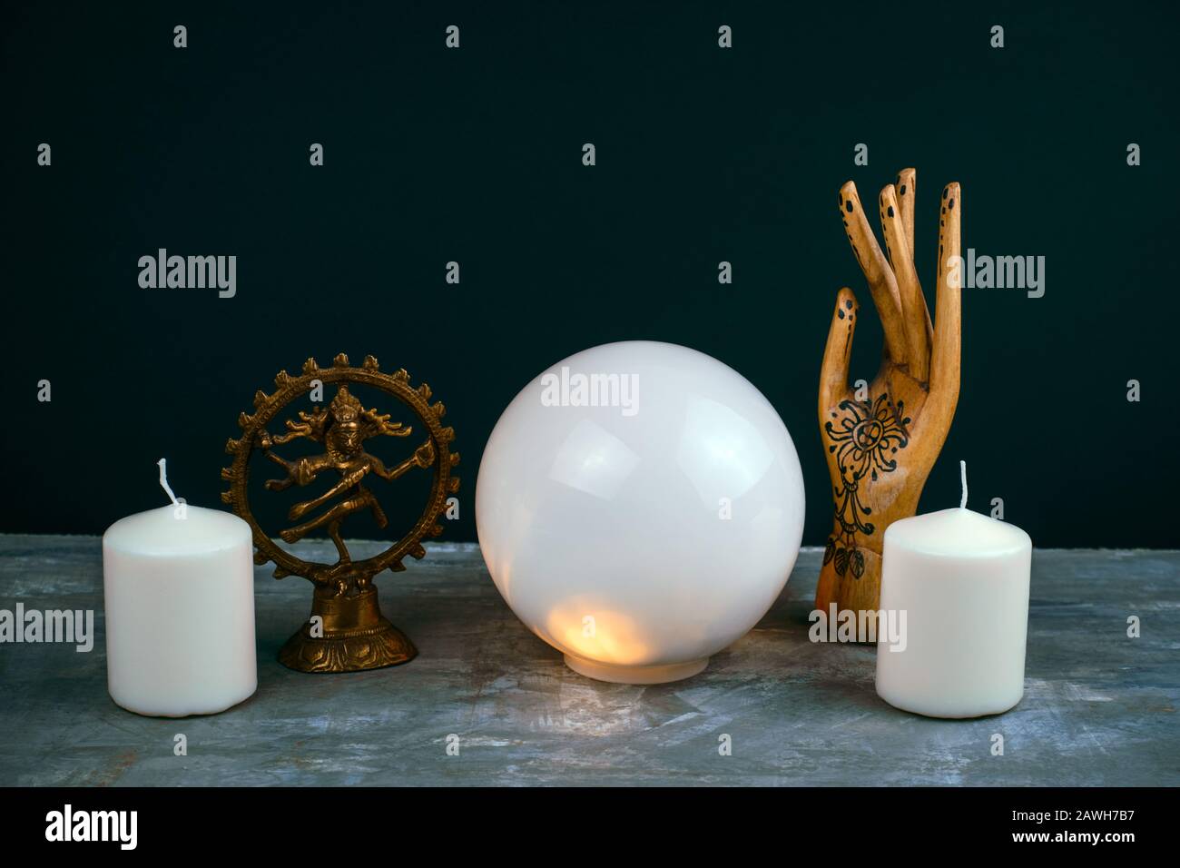 esoteric still life with a crystal ball, statuette of the God Shiva and ...