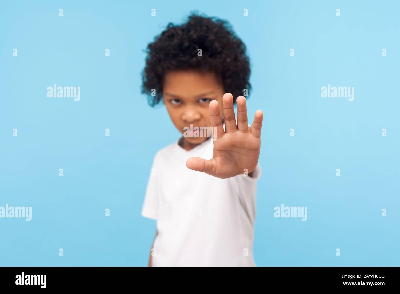 No, forbidden! Portrait of serious angry little boy with curly hair ...