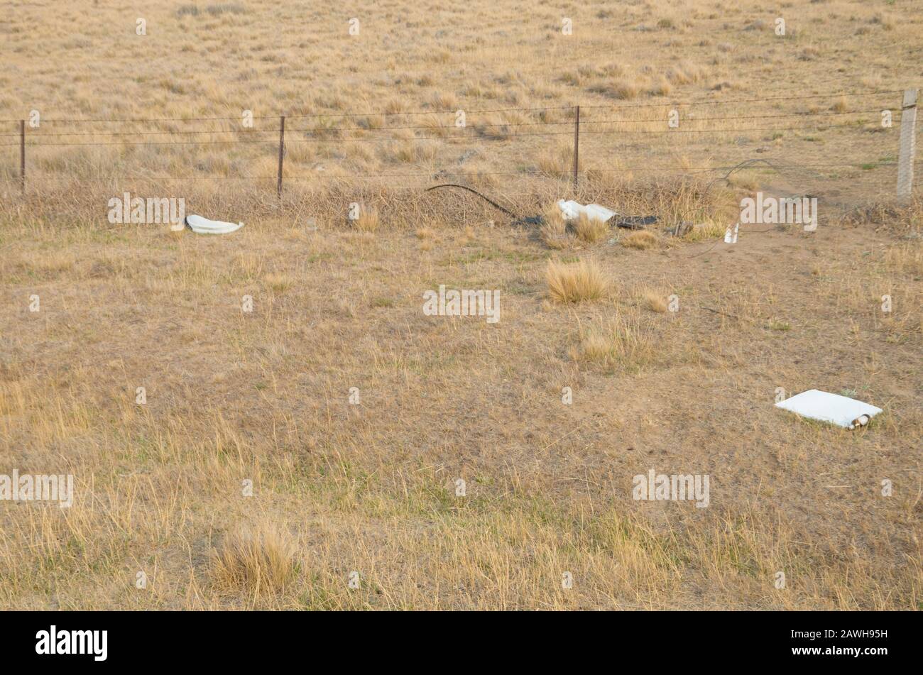 Roadside trash lying in dry grass after being dumped out of cars Stock ...
