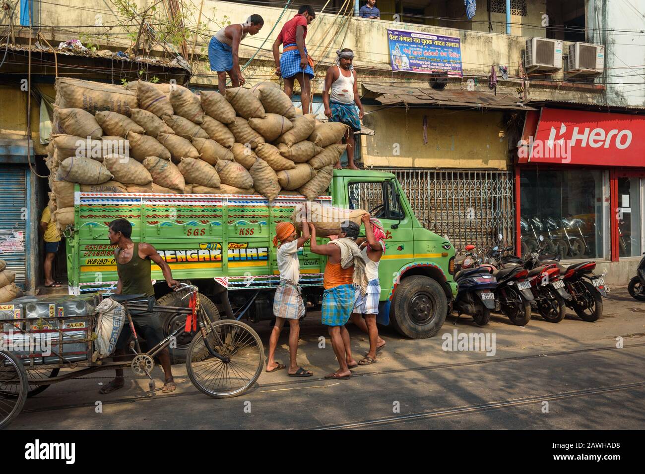 Workers loading cargo bags in truck on the street in Kolkata. India ...
