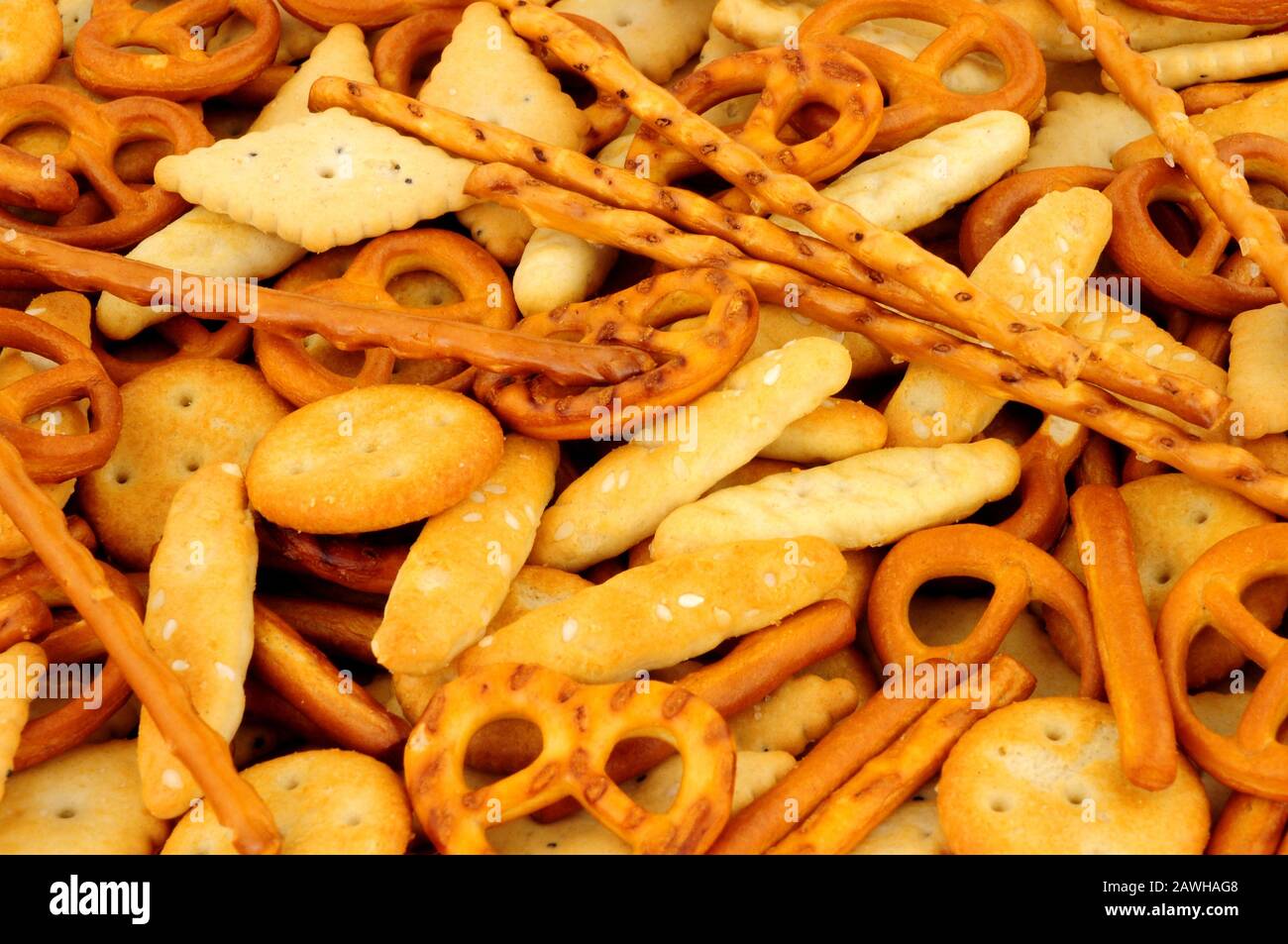 Savoury pretzel and cracker snack mix background Stock Photo - Alamy