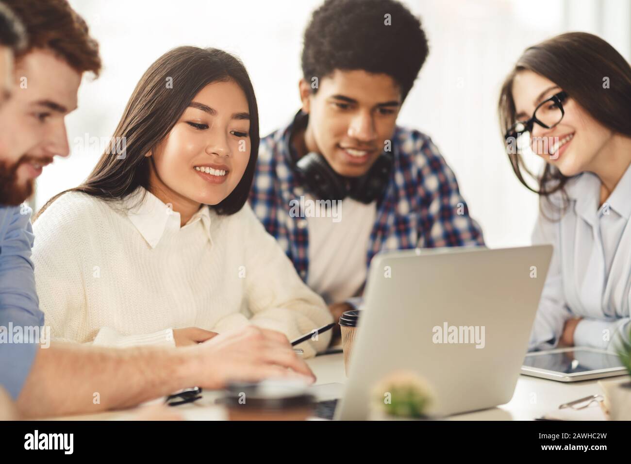 Multiethnic college students checking test results on laptop Stock ...