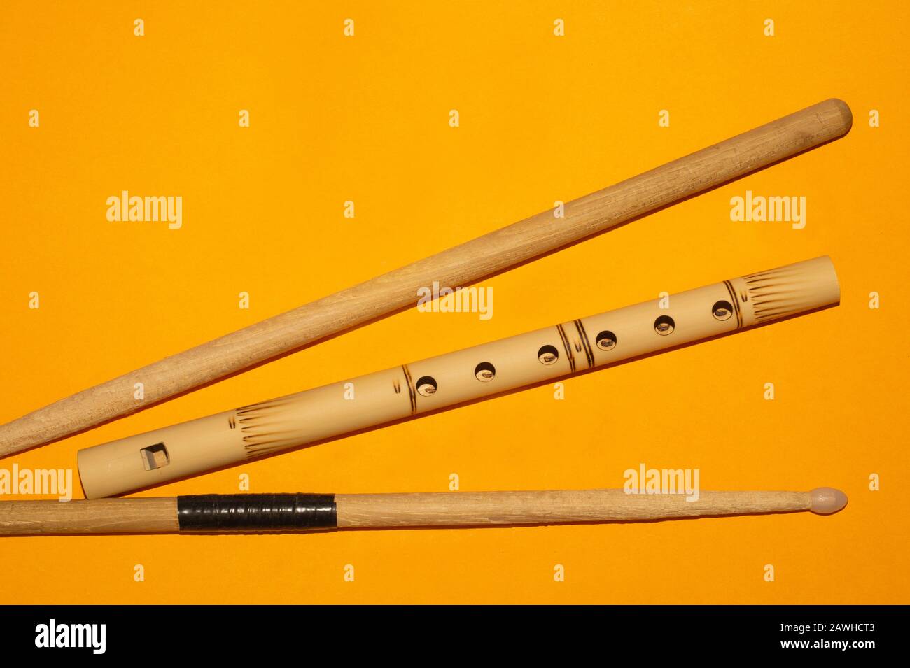 Bamboo bansuri flute and drumsticks. simple music instruments Stock ...