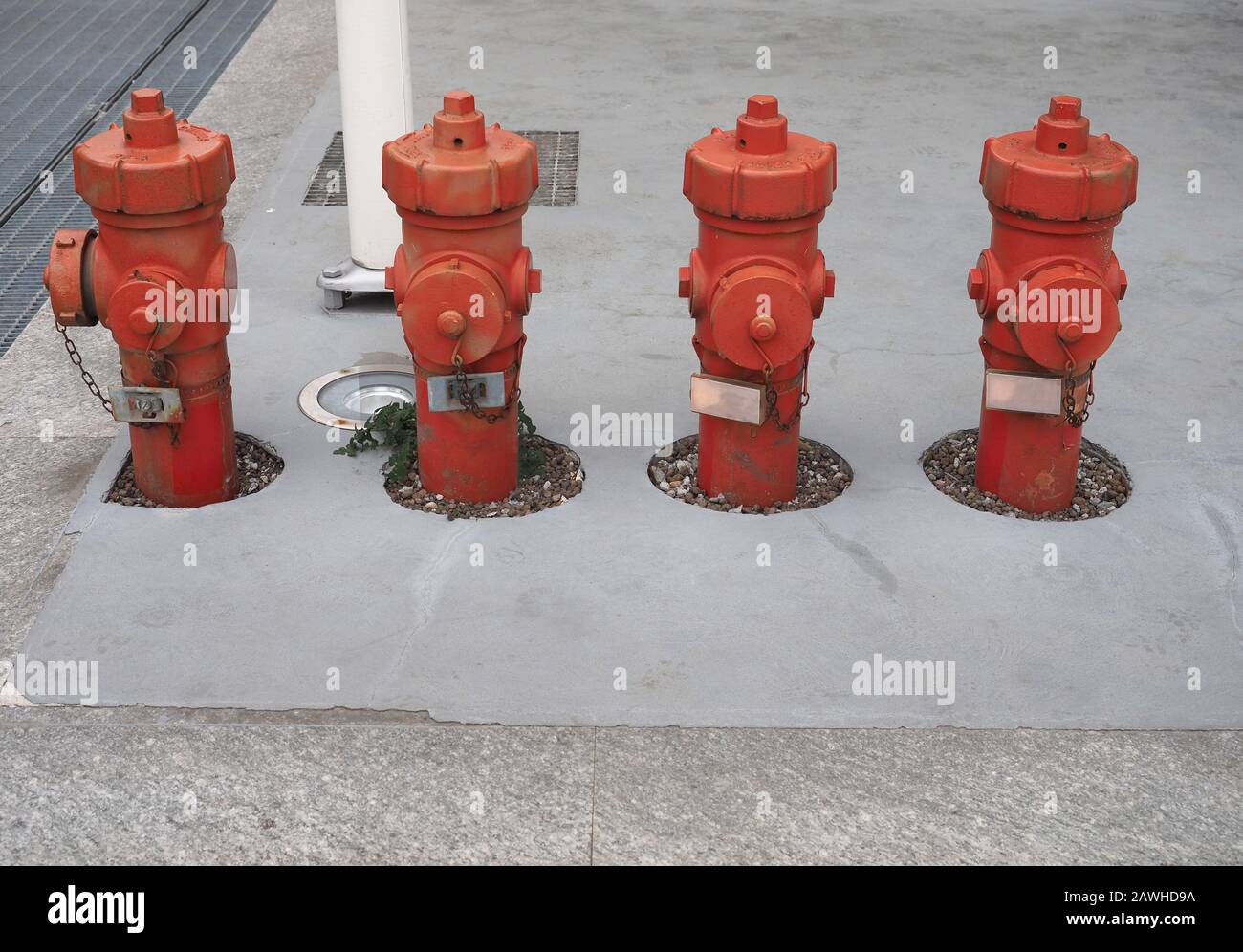 row of fire hydrants on concrete pavement Stock Photo - Alamy