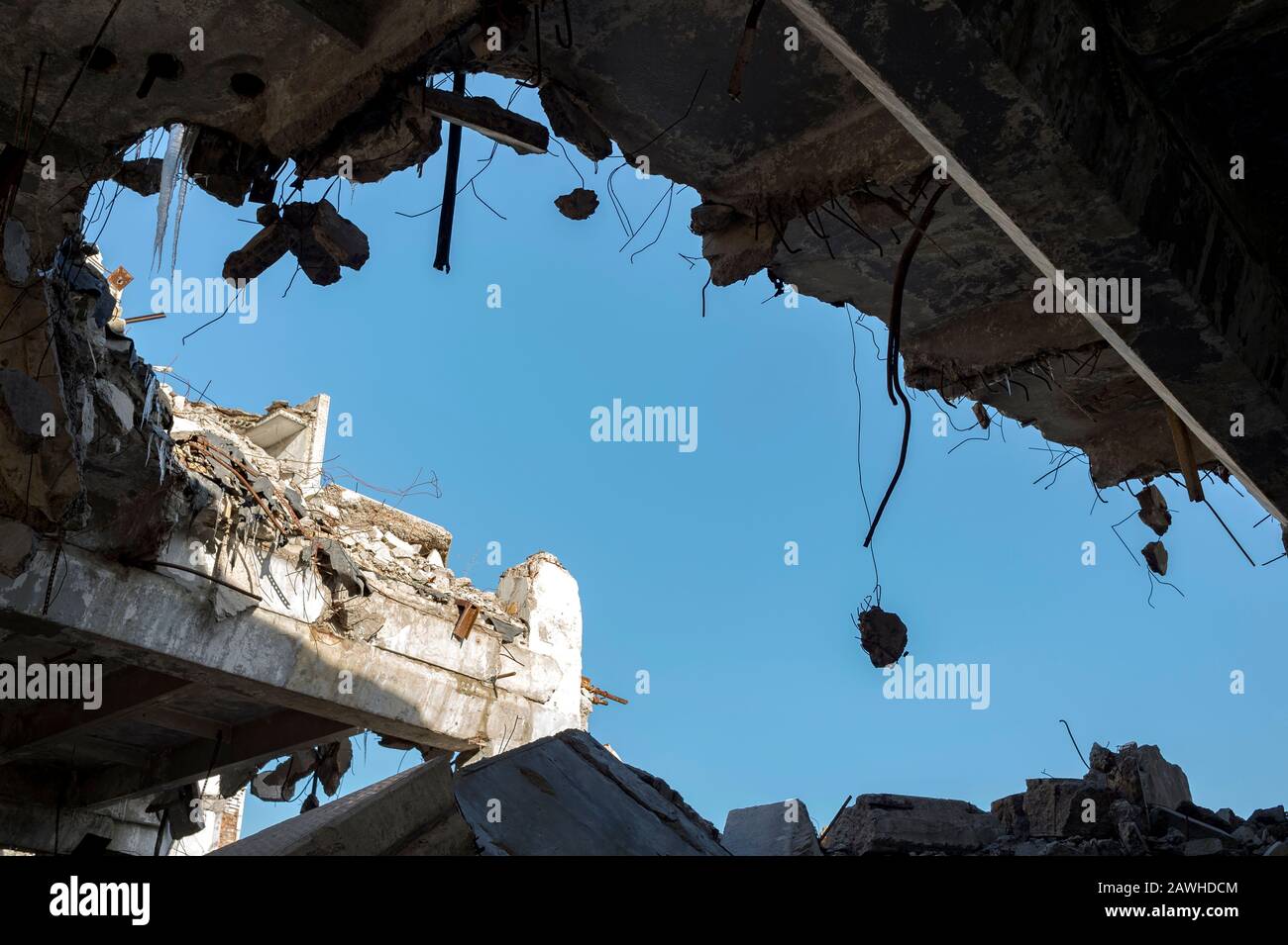 Destruction of buildings. A huge gap in the concrete slab with concrete ...