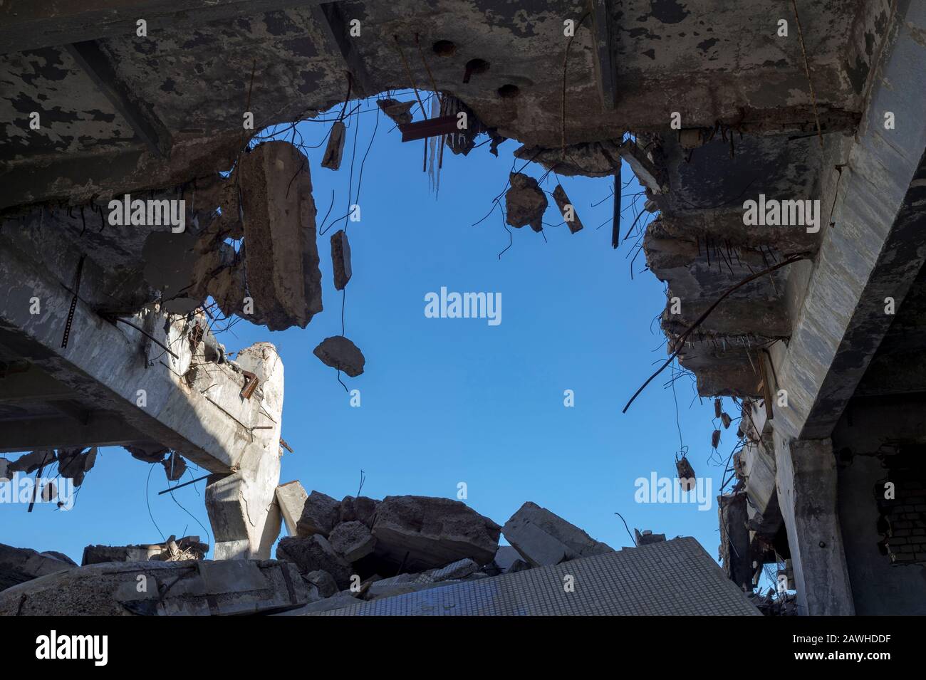 Destruction of buildings. A huge gap in the concrete slab with concrete ...
