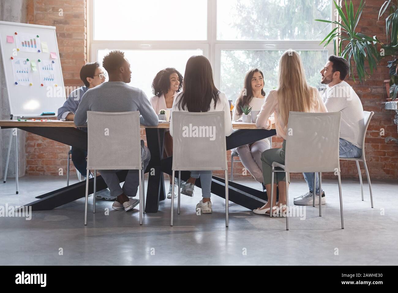 Young multiracial business team having morning briefing Stock Photo - Alamy