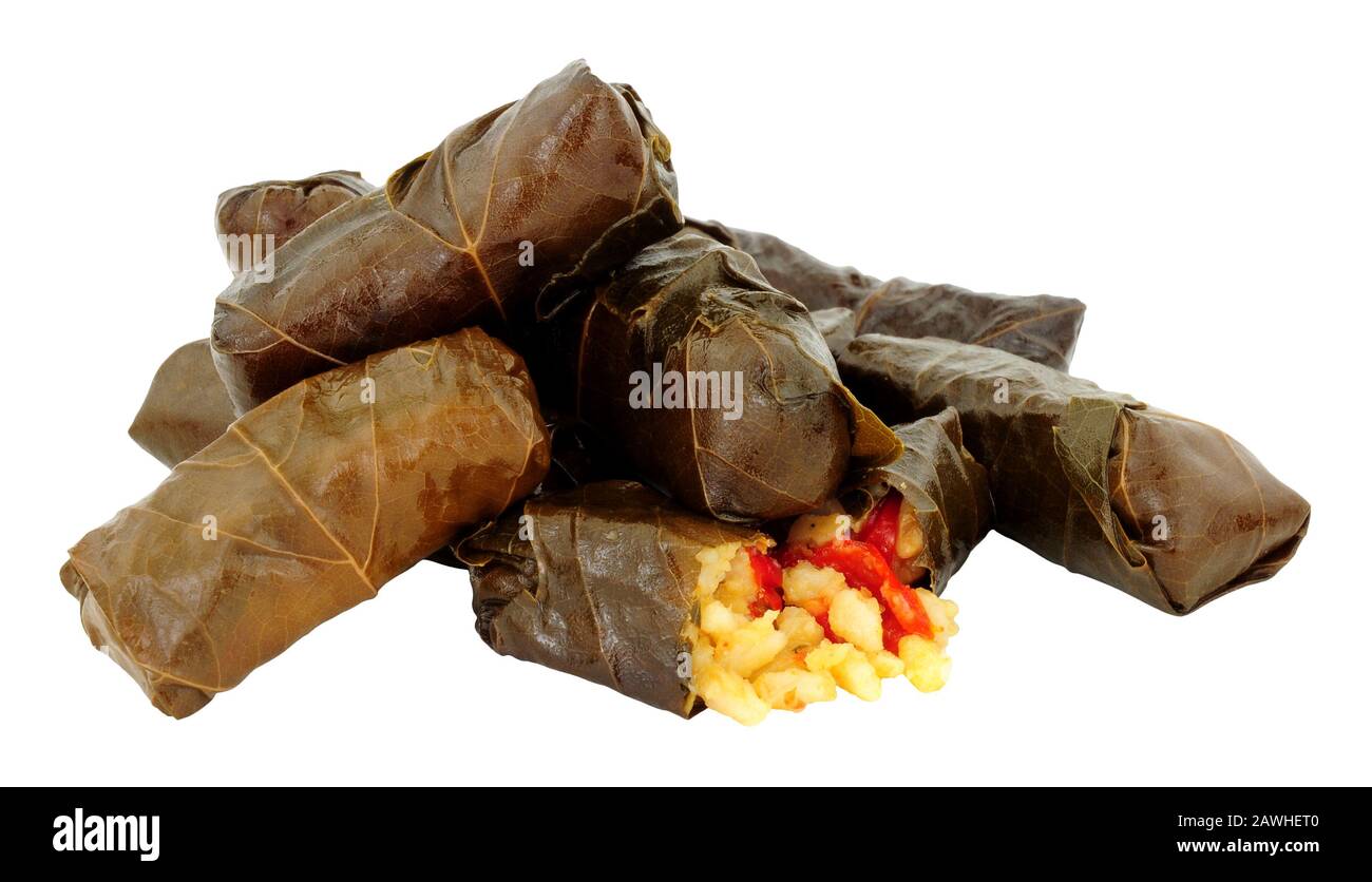 Rice and red pepper filled vine leaves isolated on a white background ...