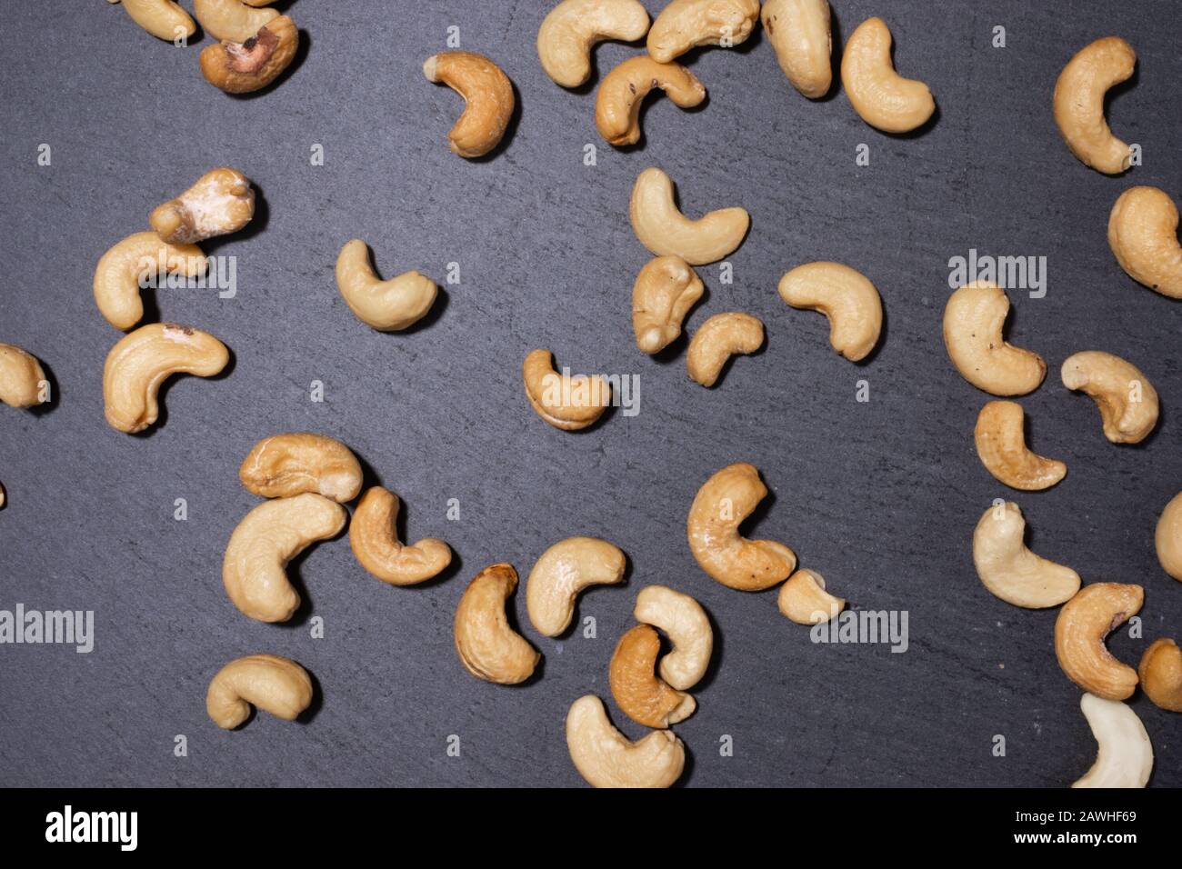 Salted cashew nuts on a black background. Healthy snack Stock Photo - Alamy