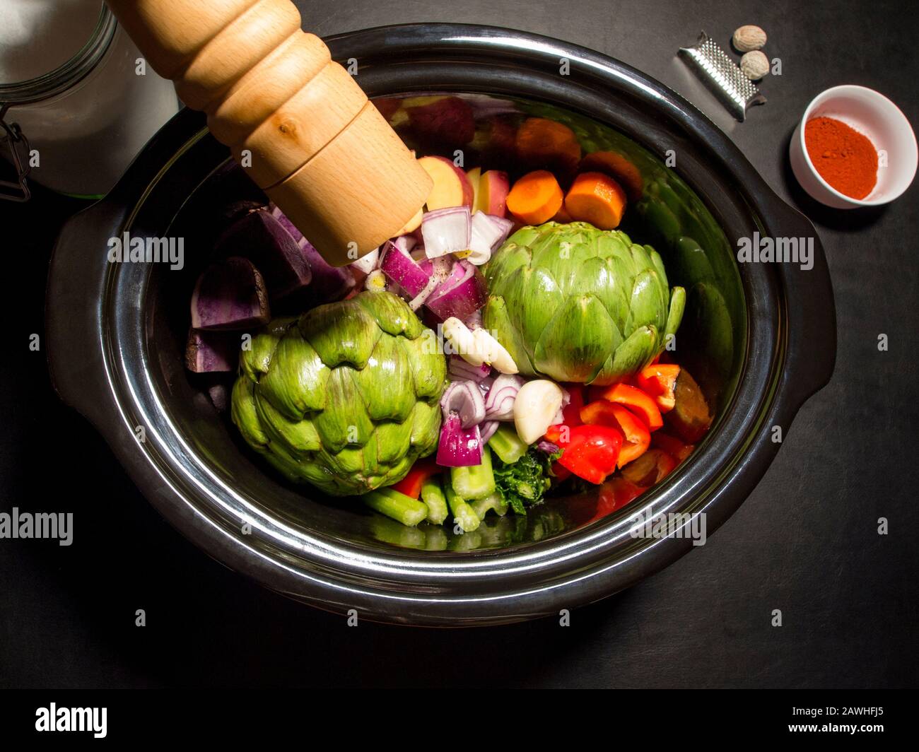 Big black pot with chopped vegetables on it ready to cook. Pepper ...