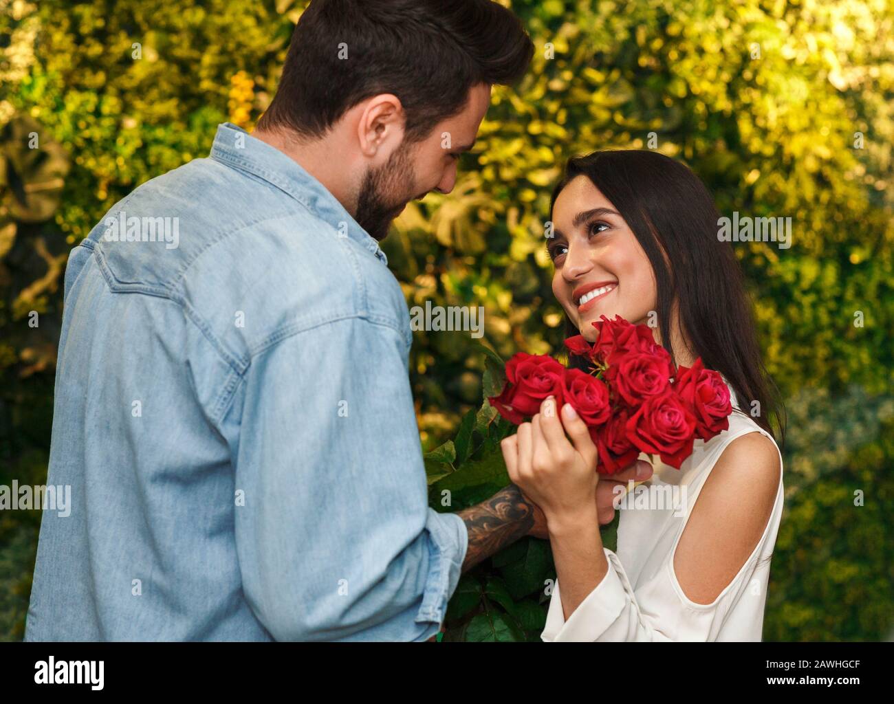 Boyfriend Giving Roses To Girlfriend On Valentine's Day In Cafe Stock ...