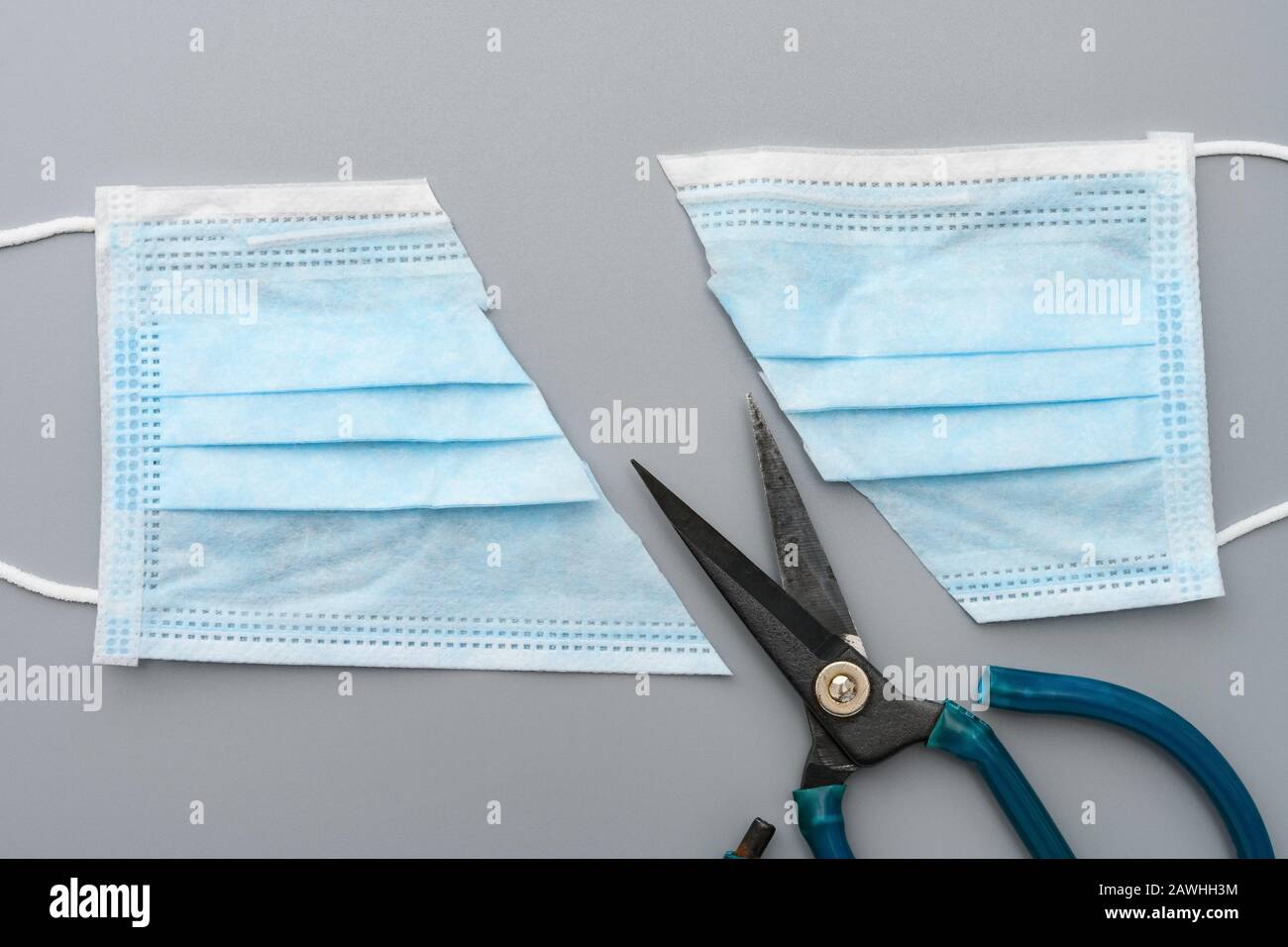 cut out medical face mask and scissors on grey background concept of ...