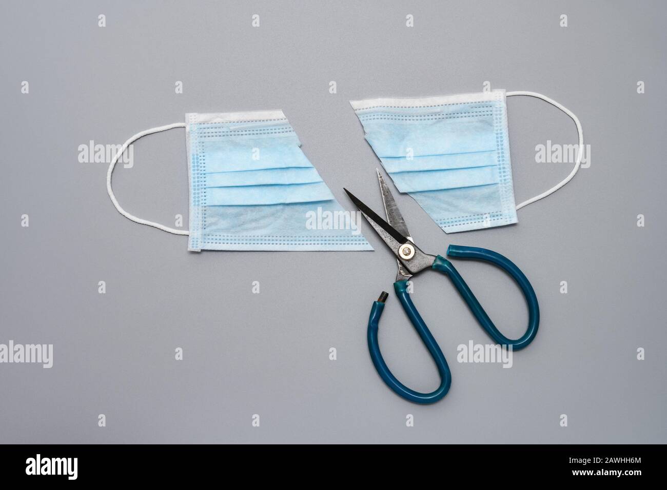 cut out medical face mask and scissors on grey background concept of ...