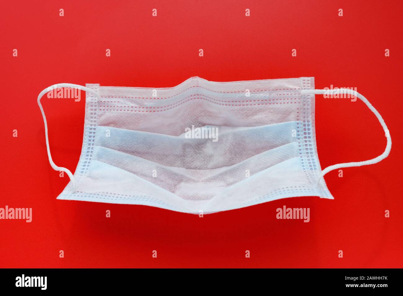 inside of an used medical face mask on red background Stock Photo - Alamy
