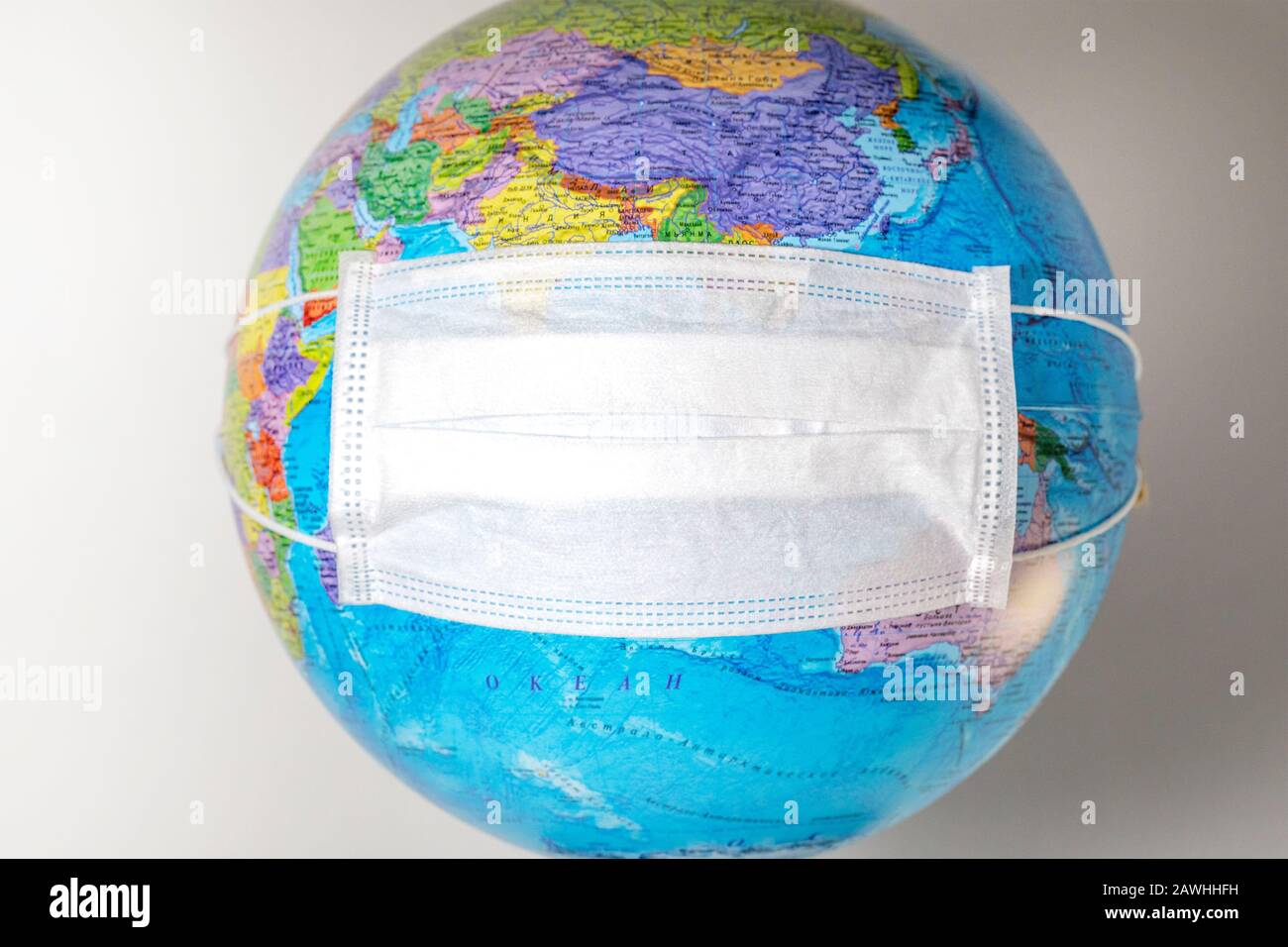 Globe with a medical mask on a white background (concepts - ecology ...