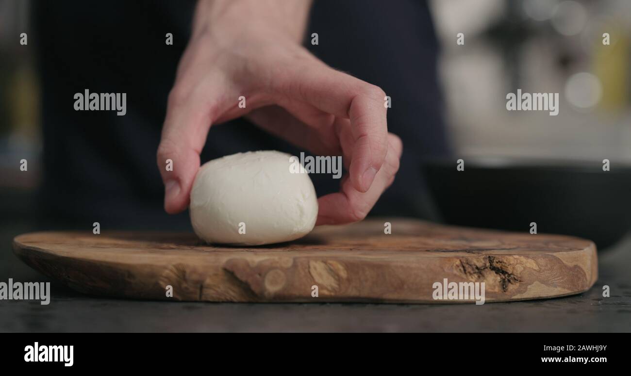 Chef slicing cheese on wooden hi-res stock photography and images - Alamy