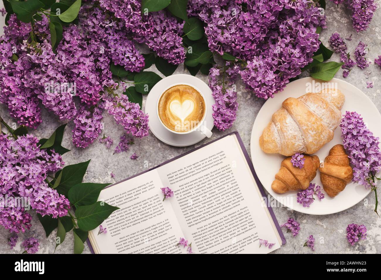 Spring background with lilac, coffee and book Stock Photo - Alamy
