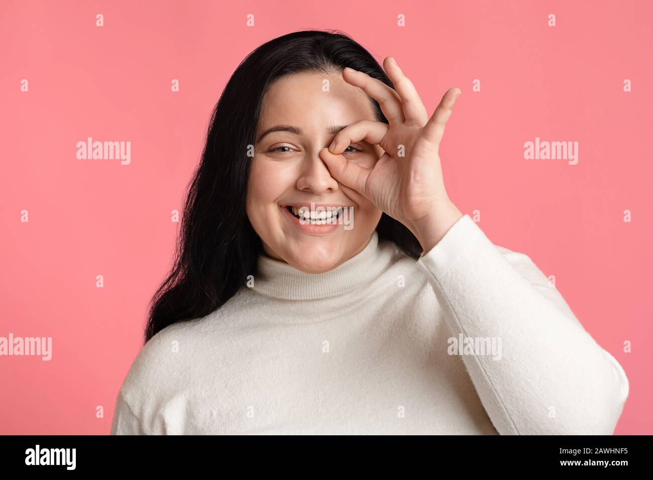 Plump Girl Looking Through Ok Sign Gesture, Posing Over Pink Background ...