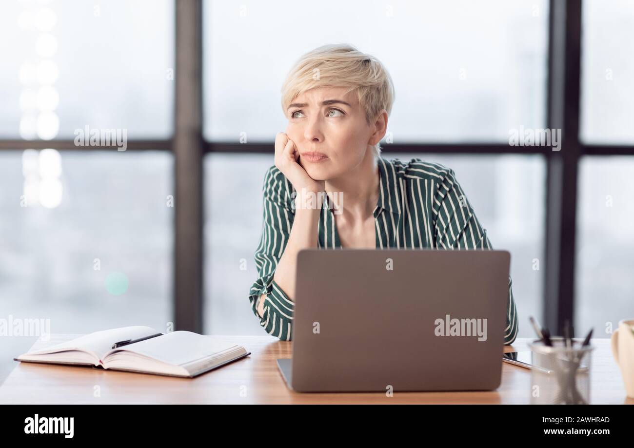 Unmotivated lady sitting workplace hi-res stock photography and images ...