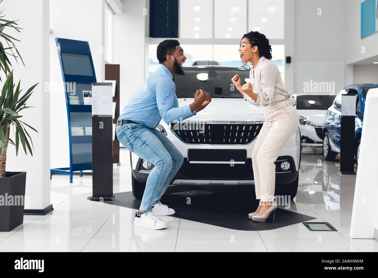 Joyful Family Couple Celebrating Buying New Car In Automobile ...