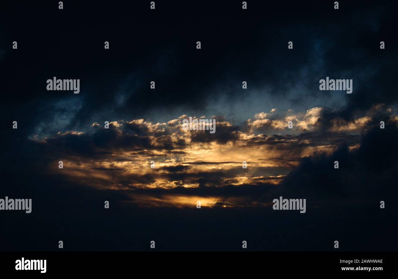 Dramatic dark evening sky landscape with moody clouds and golden ...
