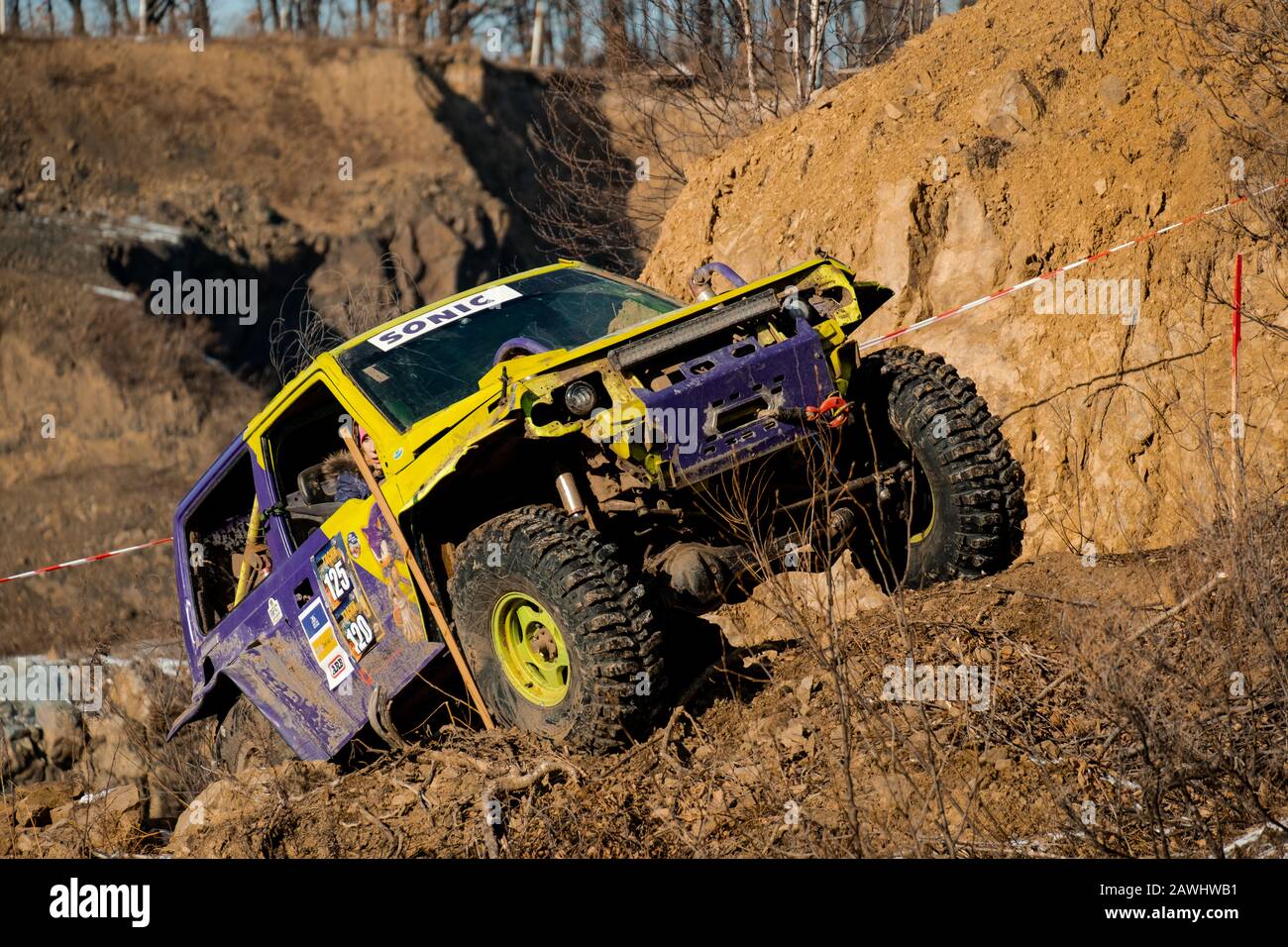 Jeep Suzuki Jimny overcomes obstacles in the forest Stock Photo - Alamy