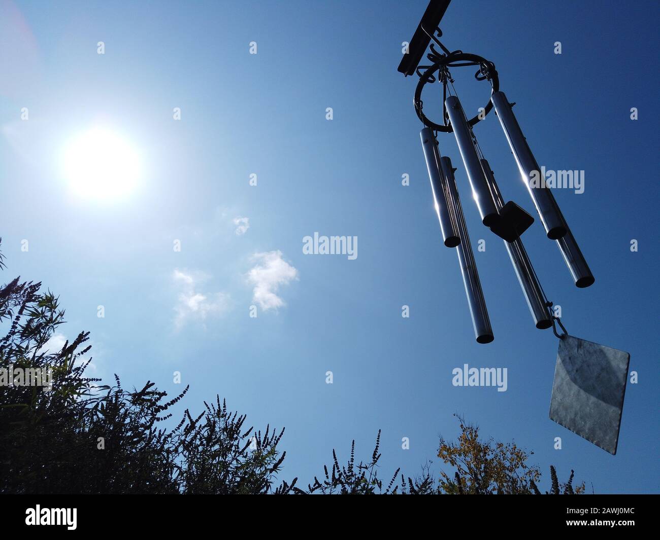 Metal Wind bells hanged on a balcony for relaxation and zen against ...