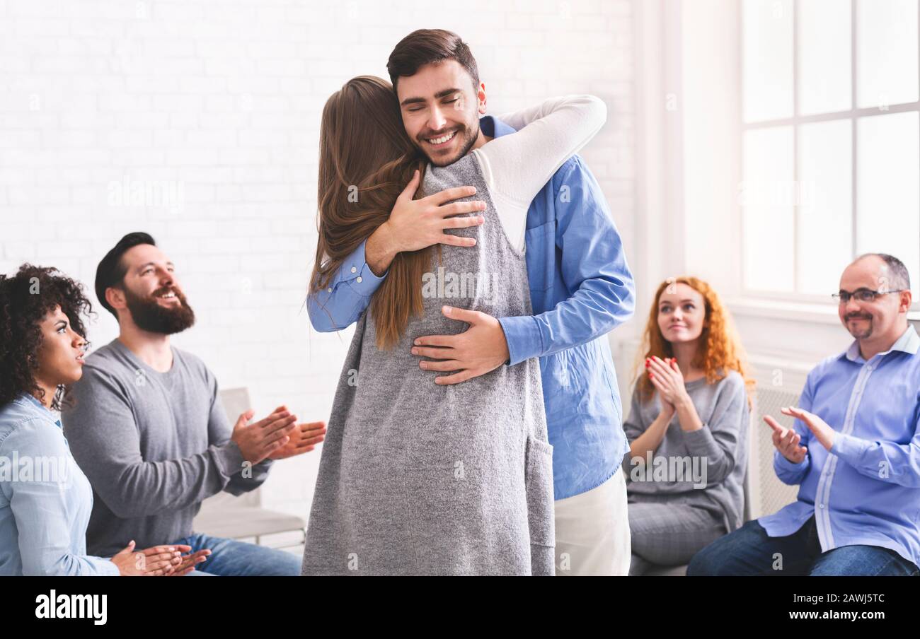 Happy Man Embracing Therapy Group Member After Treating Social Anxiety ...