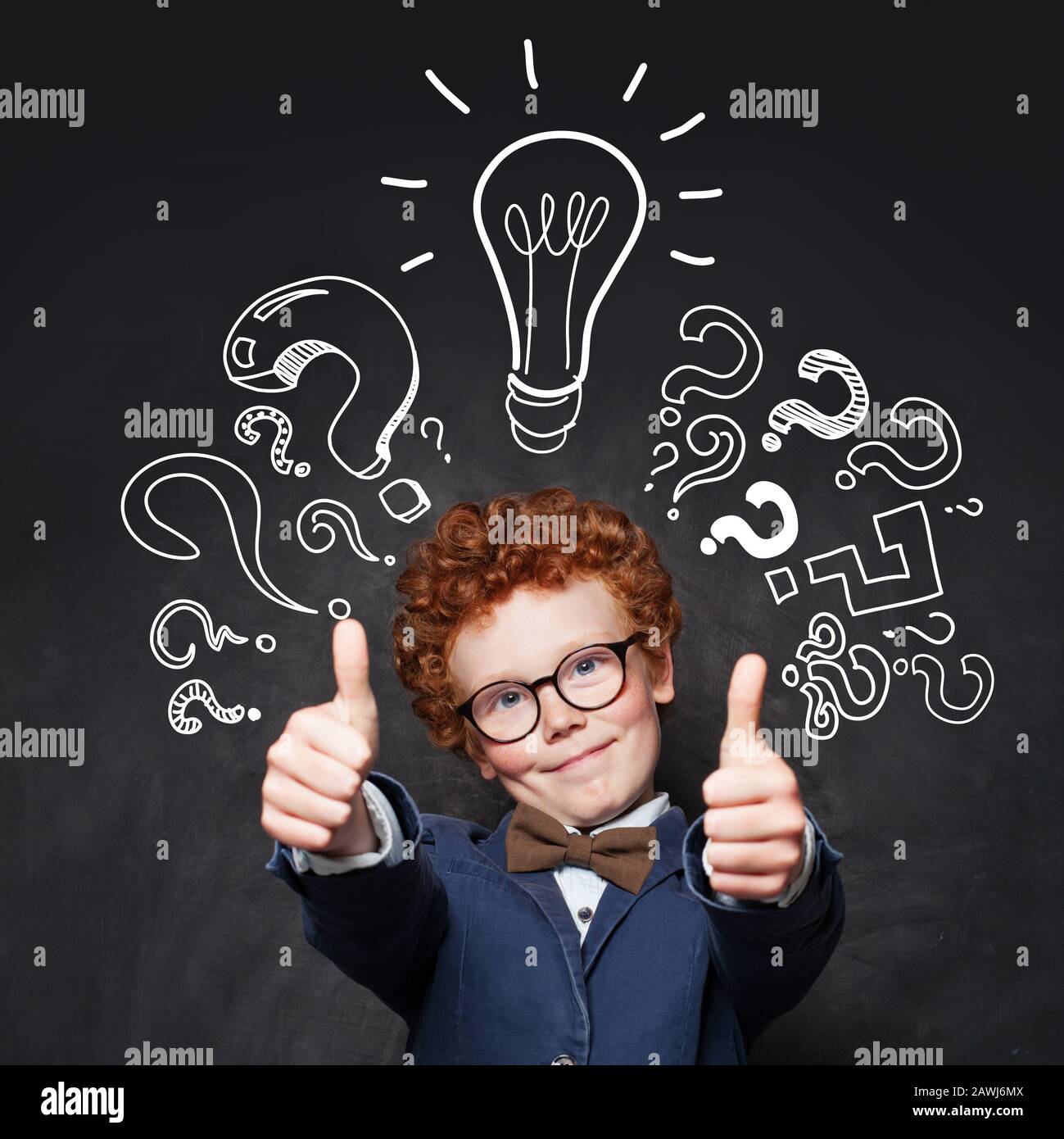 Child 9 years old having fun and showing thumb up on blackboard ...