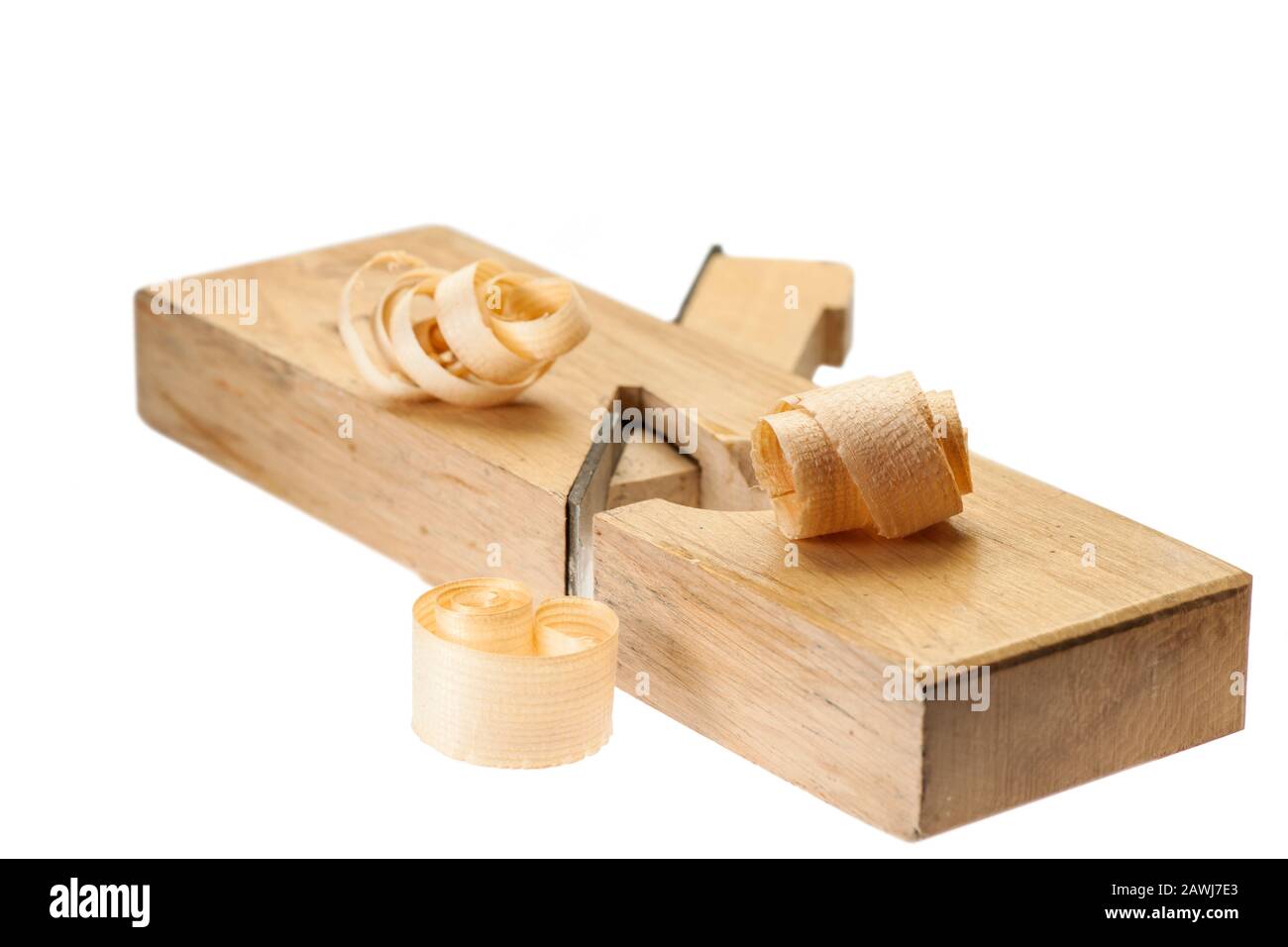 Low angle view of a side plane with three rolled shavings on a white ...