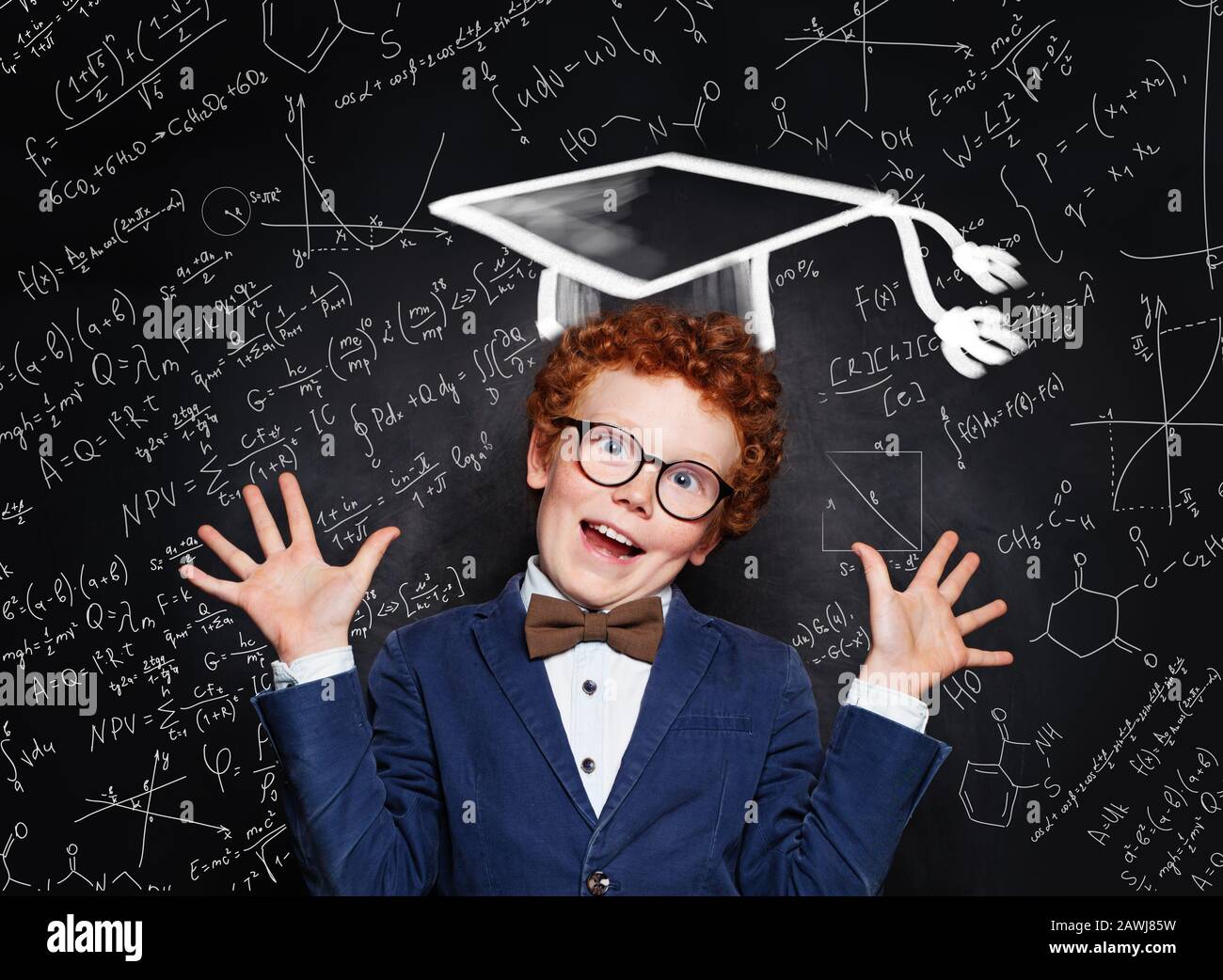 Funny kid with red hair, glasses and graduation hat against science ...