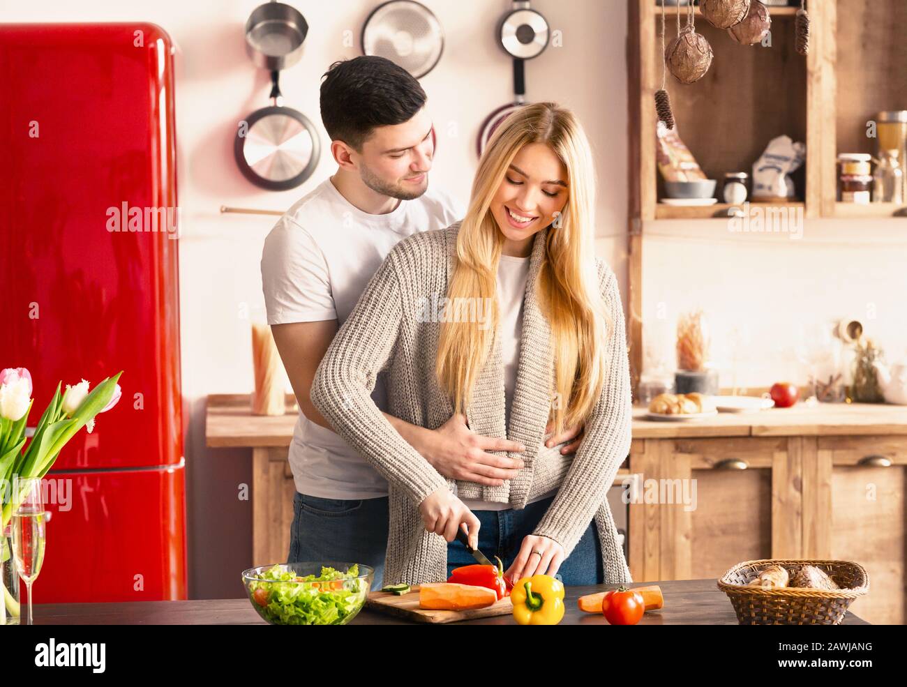 Just married young couple embracing and cooking together Stock Photo ...