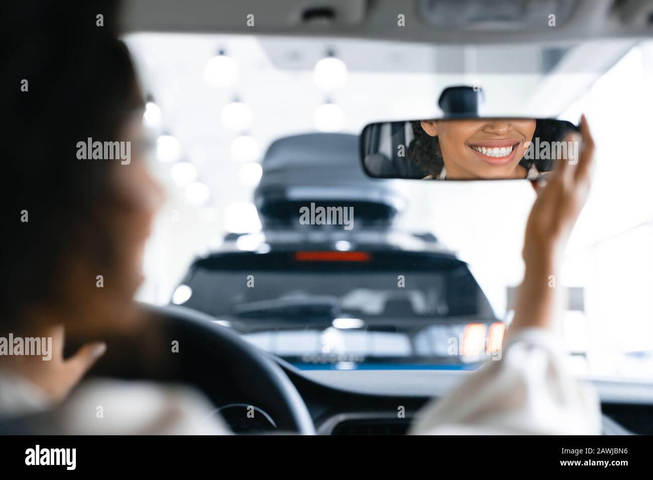 Unrecognizable Woman In Driver's Seat Checking Mirrors In Dealership ...