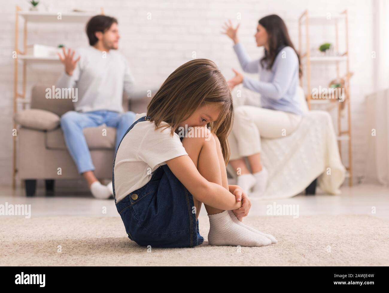 Family Conflict. Little girl crying after parents quarrel at home Stock Photo - Alamy