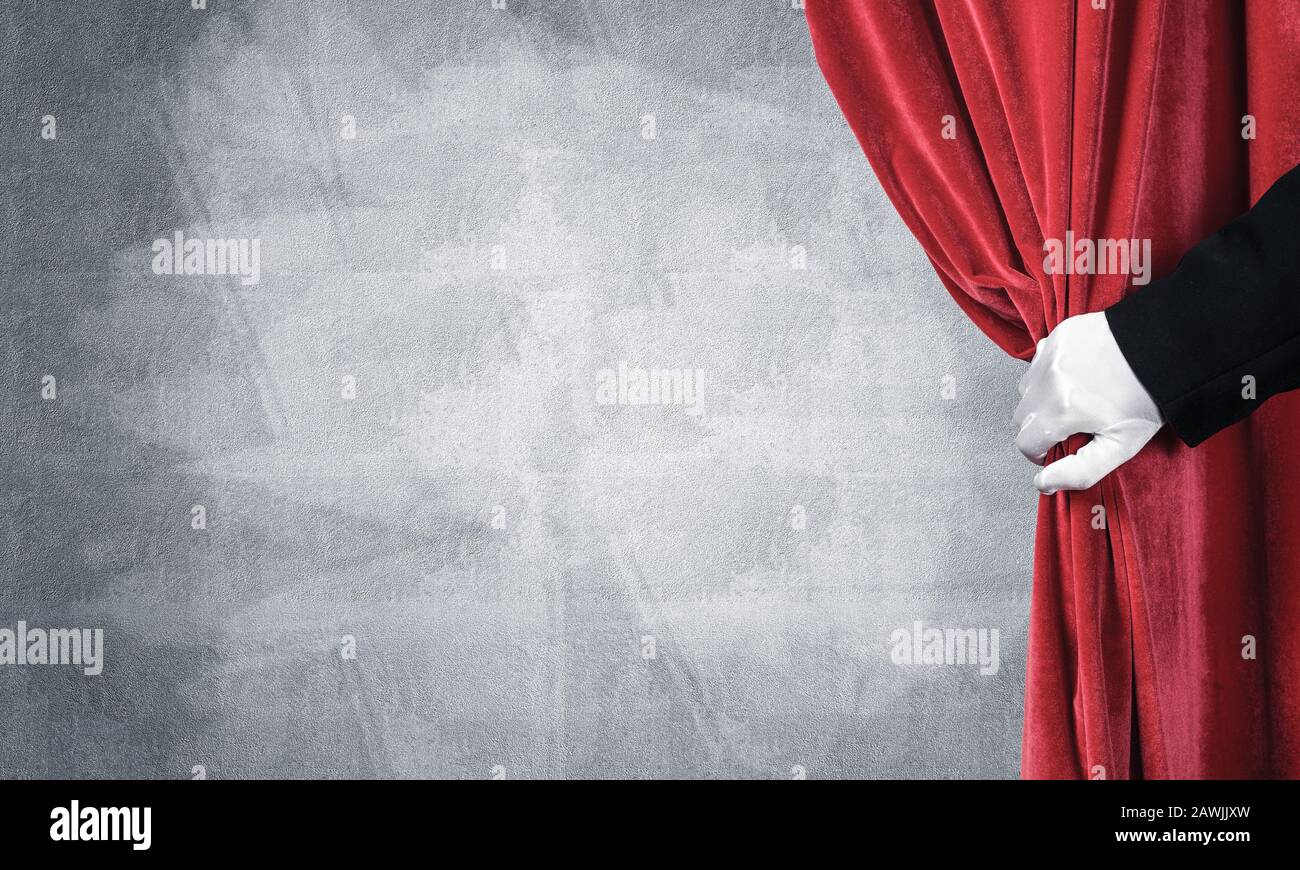 Concrete wall behind drapery curtain and hand opening it Stock Photo ...