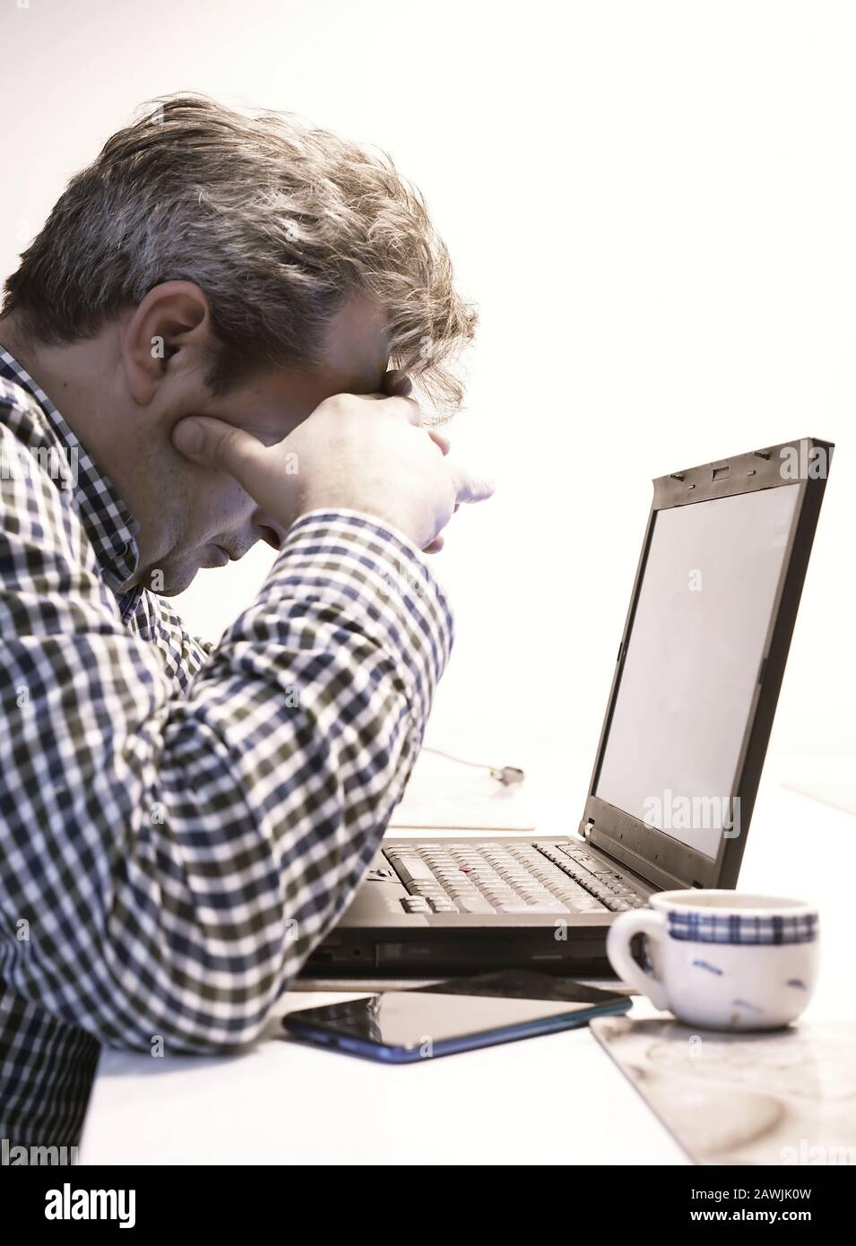 Remote IT support. Tired man works at home Stock Photo - Alamy