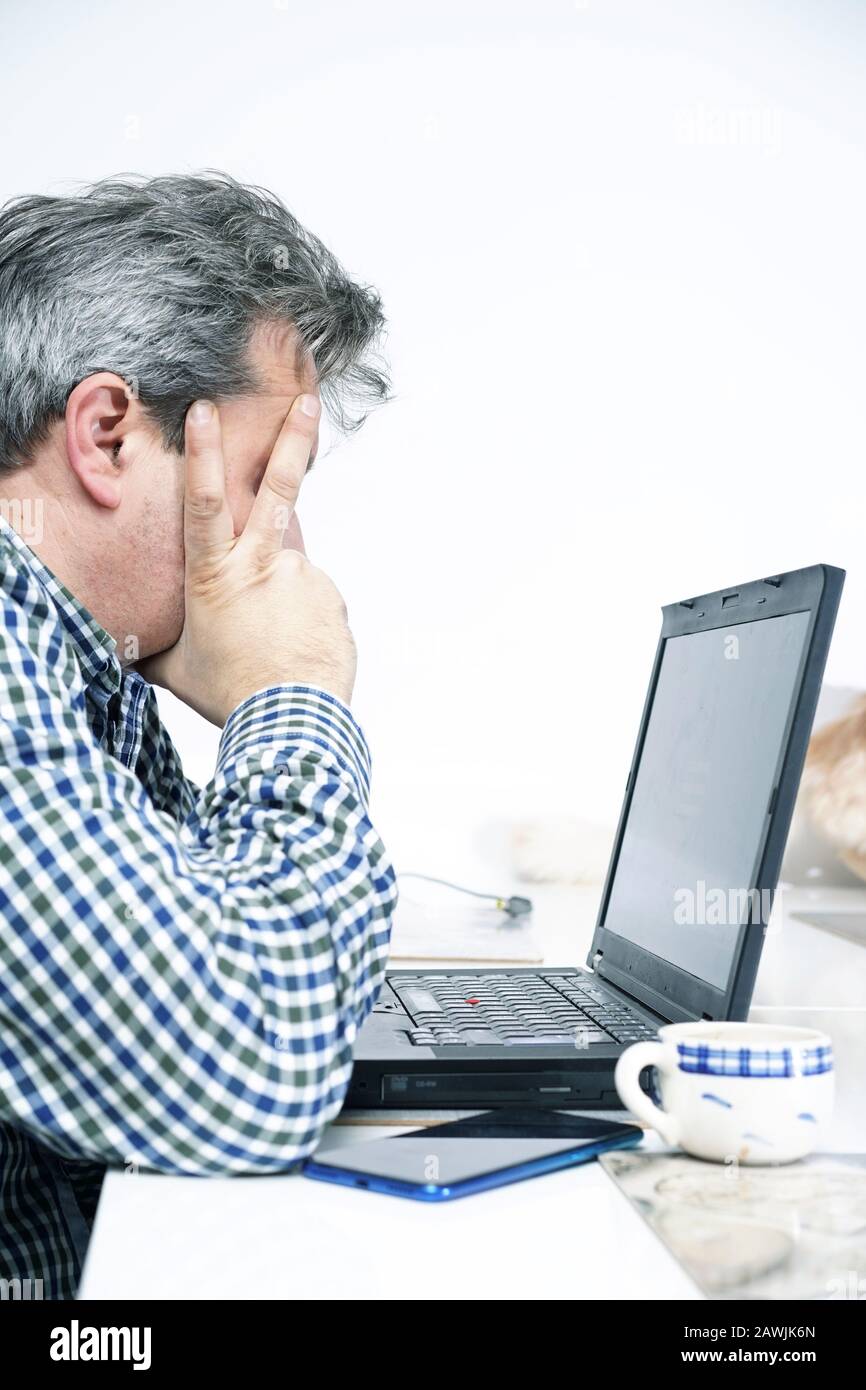 Remote IT support. Tired man works at home Stock Photo - Alamy