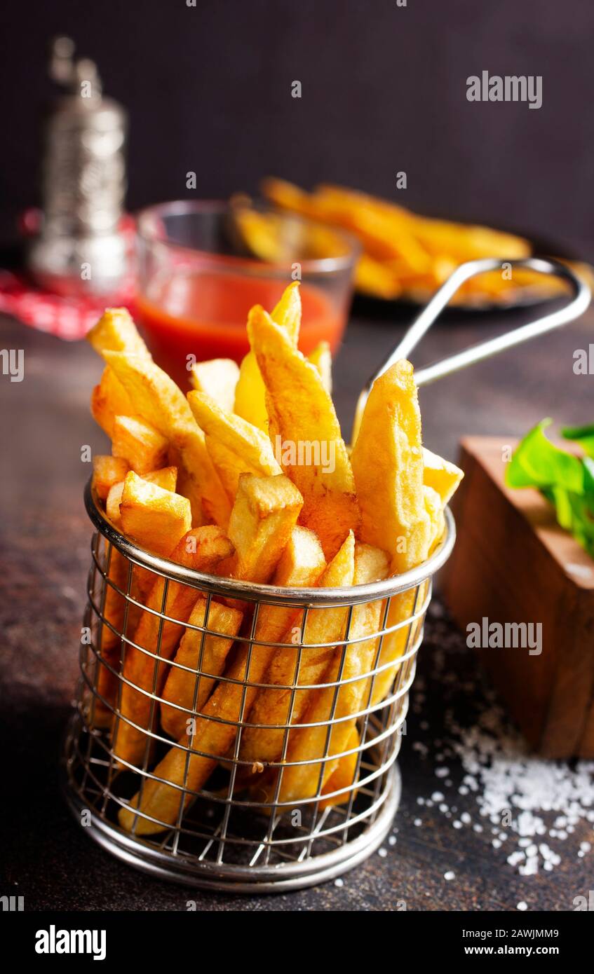 French fries serve in metal basket on a table Stock Photo - Alamy