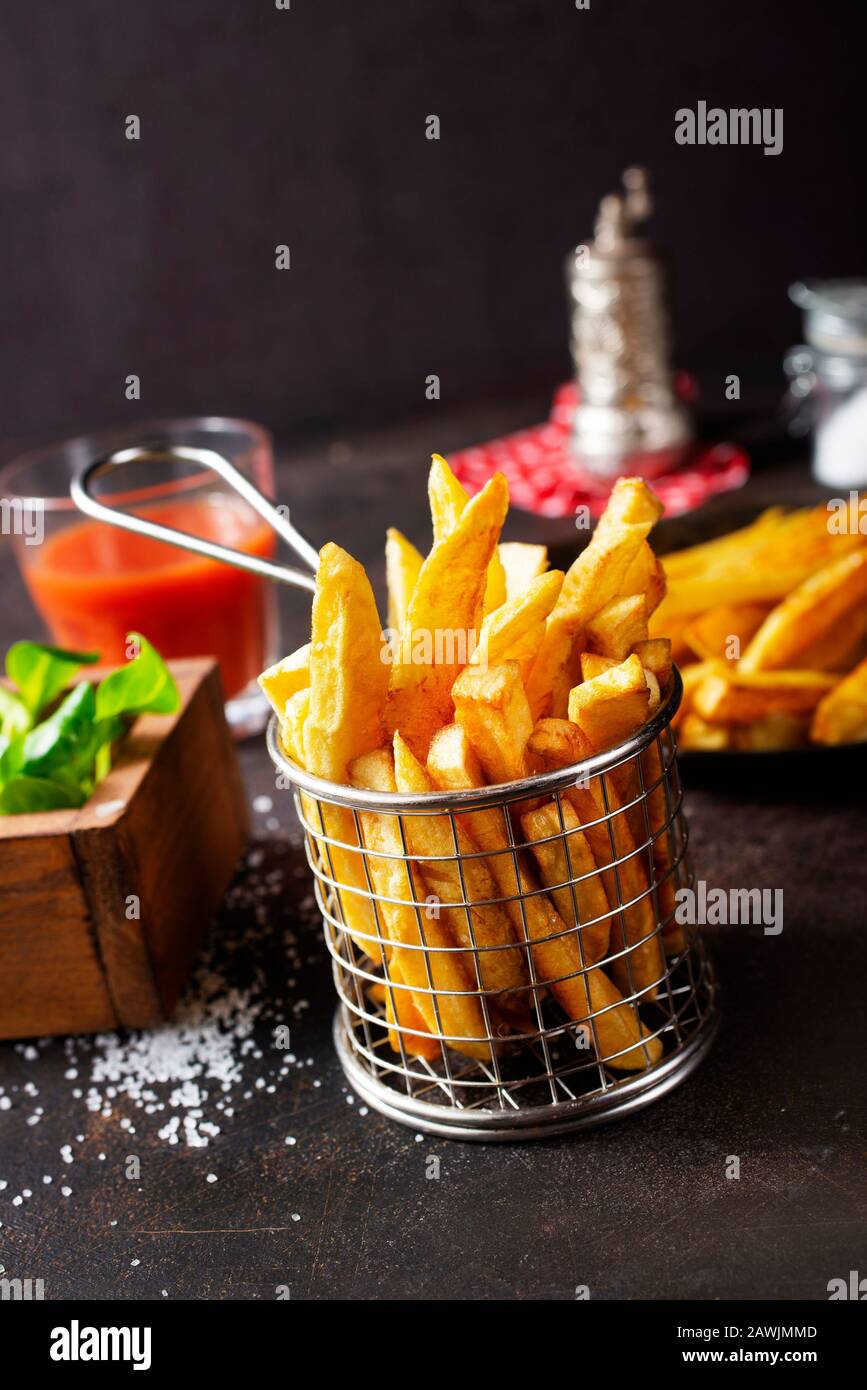 French fries serve in metal basket on a table Stock Photo - Alamy