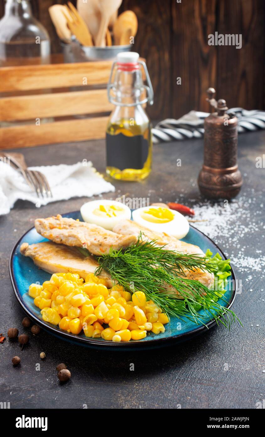 baked chicken with corn with boiled egg Stock Photo - Alamy