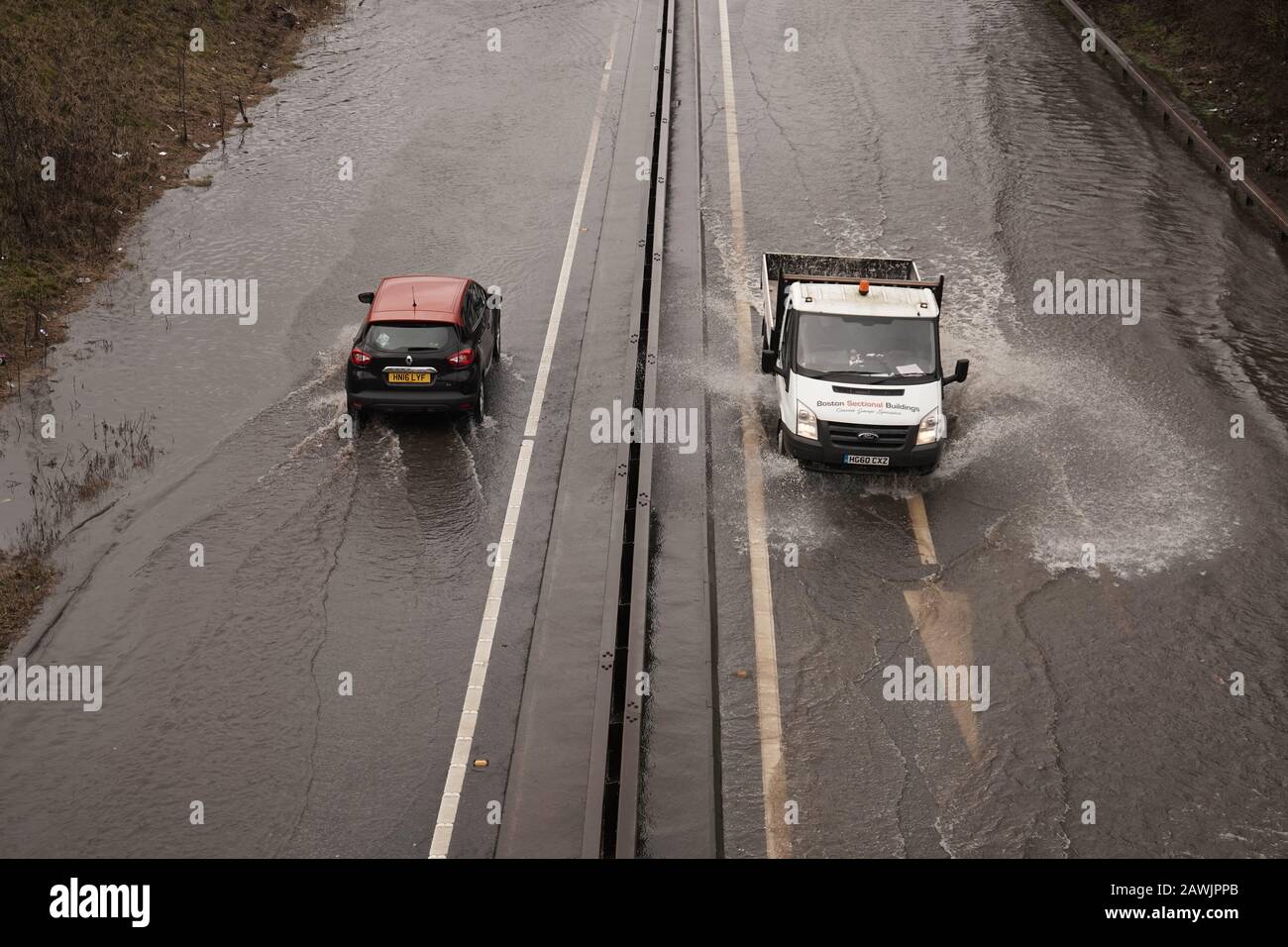 Traffic passes through water on the A66 near Bowes in County Durham, as ...