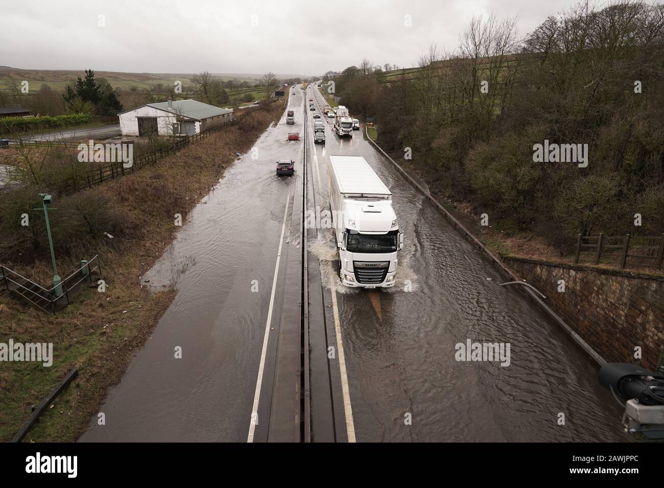 Traffic passes through water on the A66 near Bowes in County Durham, as ...