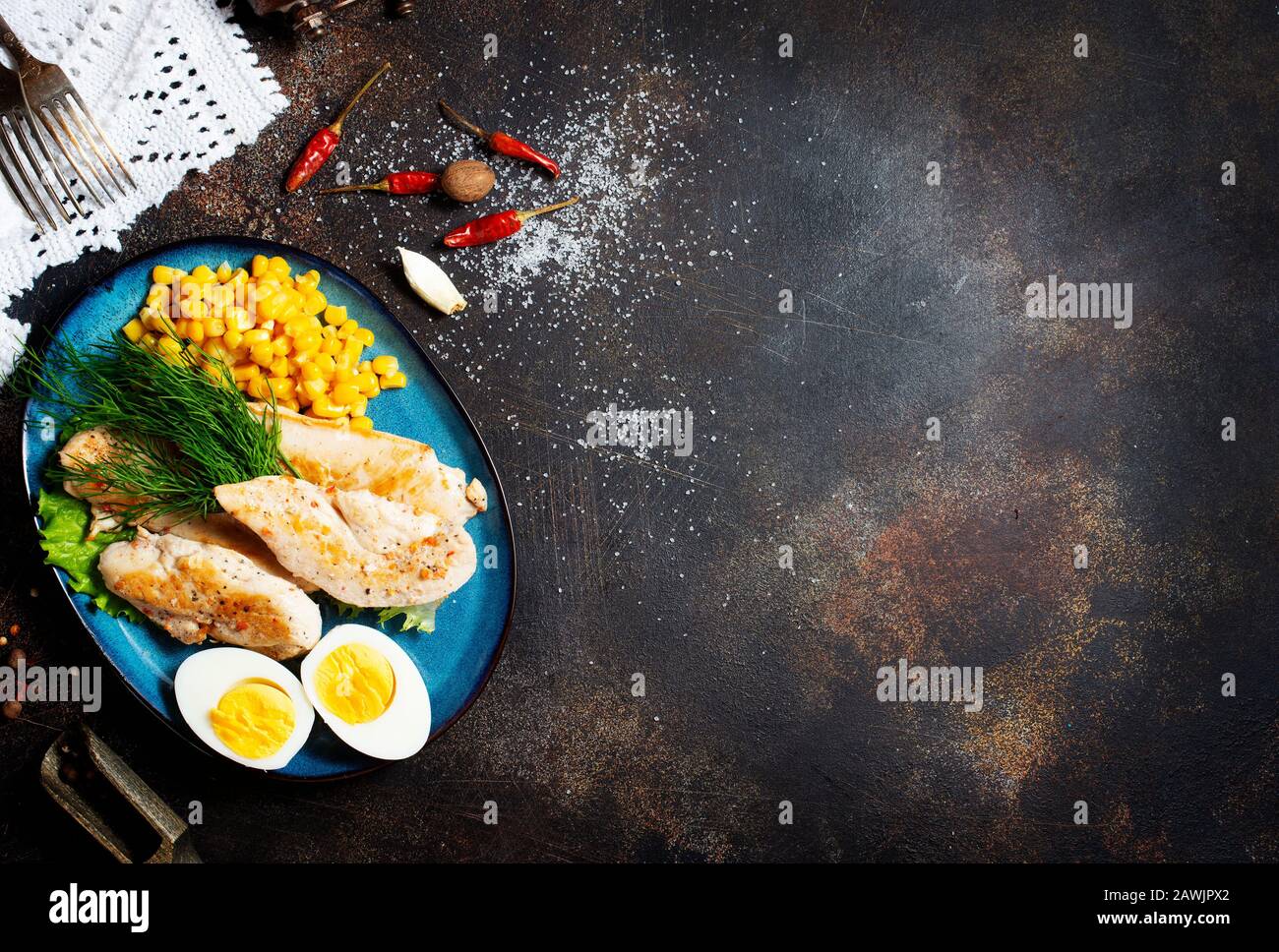 baked chicken with corn with boiled egg Stock Photo - Alamy