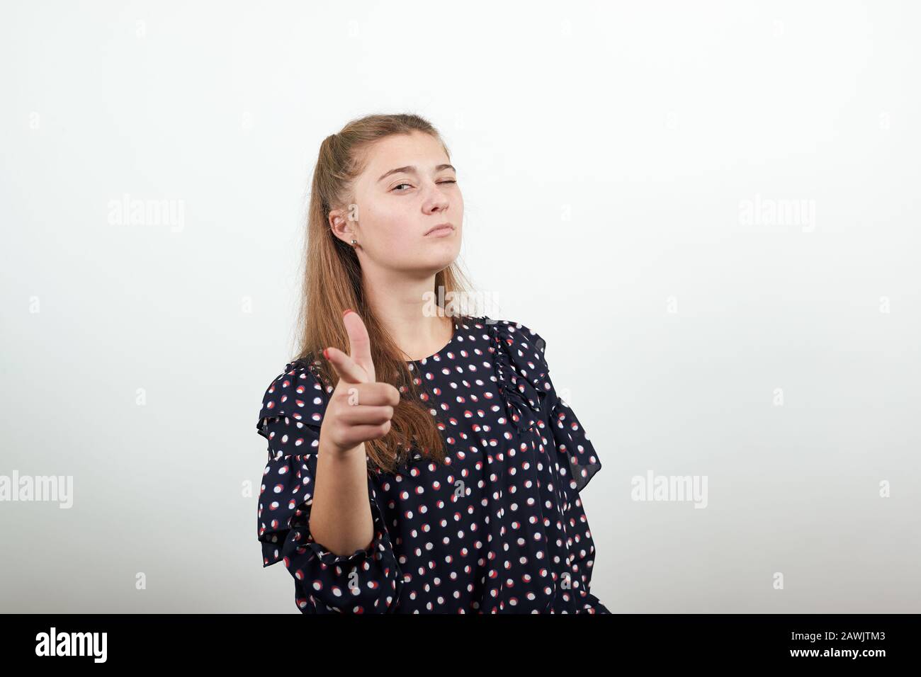 girl in a black dress stylish woman shows the direction with her index ...