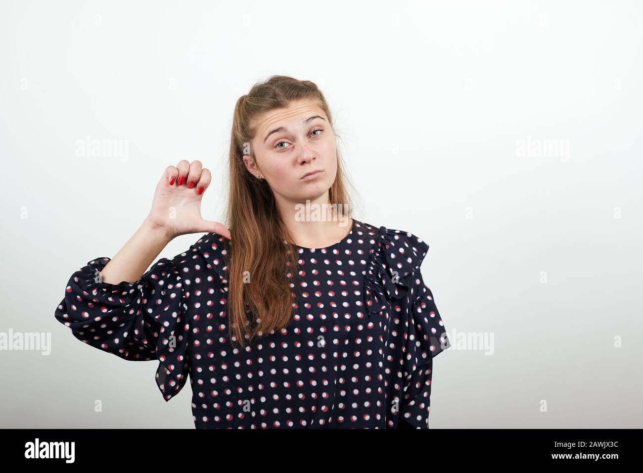 girl in a black dress angry disgruntled woman turned down her thumbs in ...