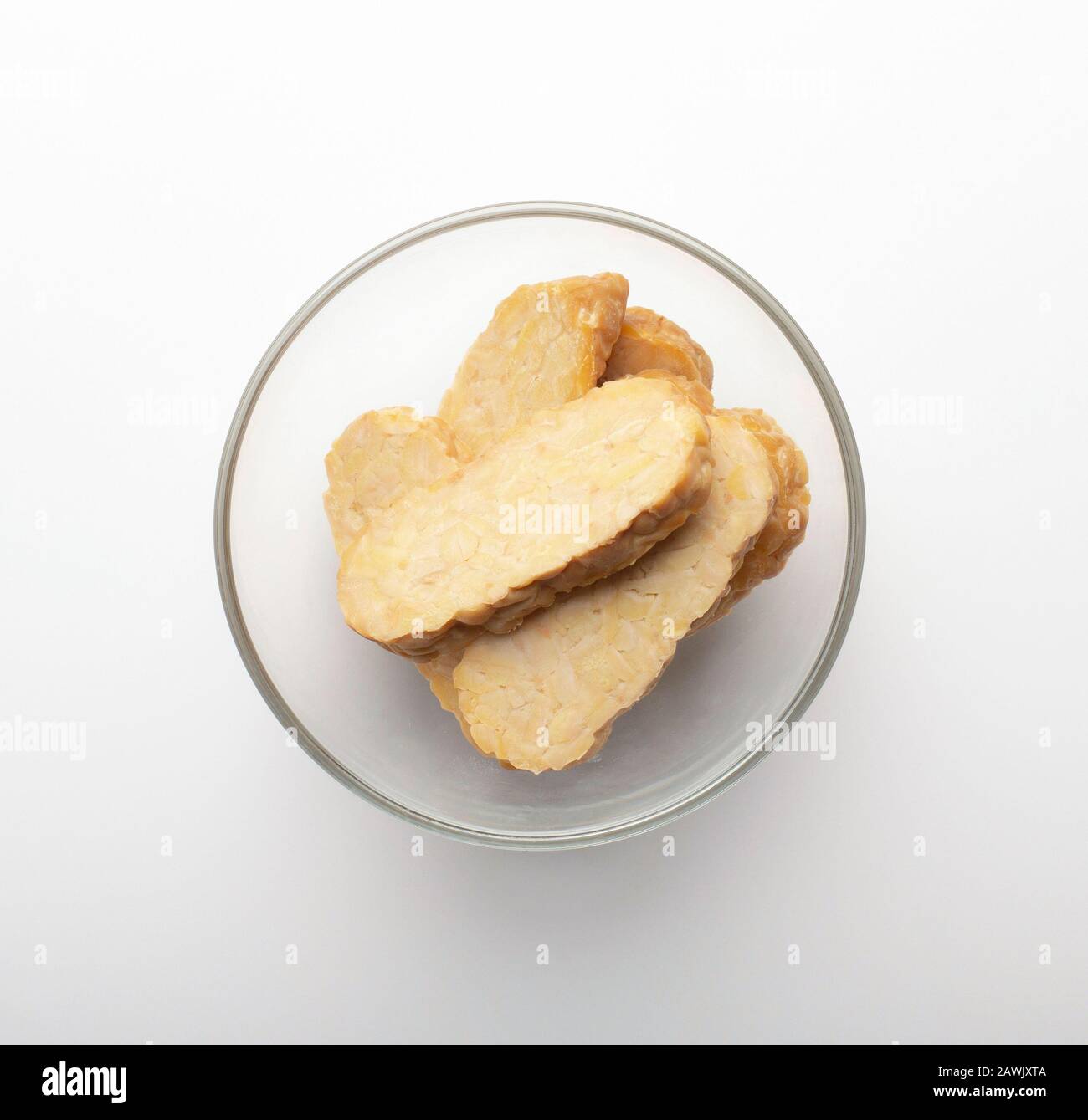 Sliced tempeh appetizer in glass bowl on white background Stock Photo ...