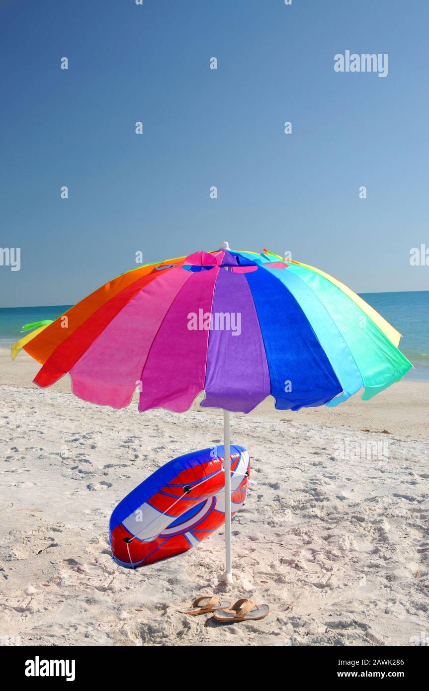 Colorful Umbrella and Float on the Beach Stock Photo - Alamy