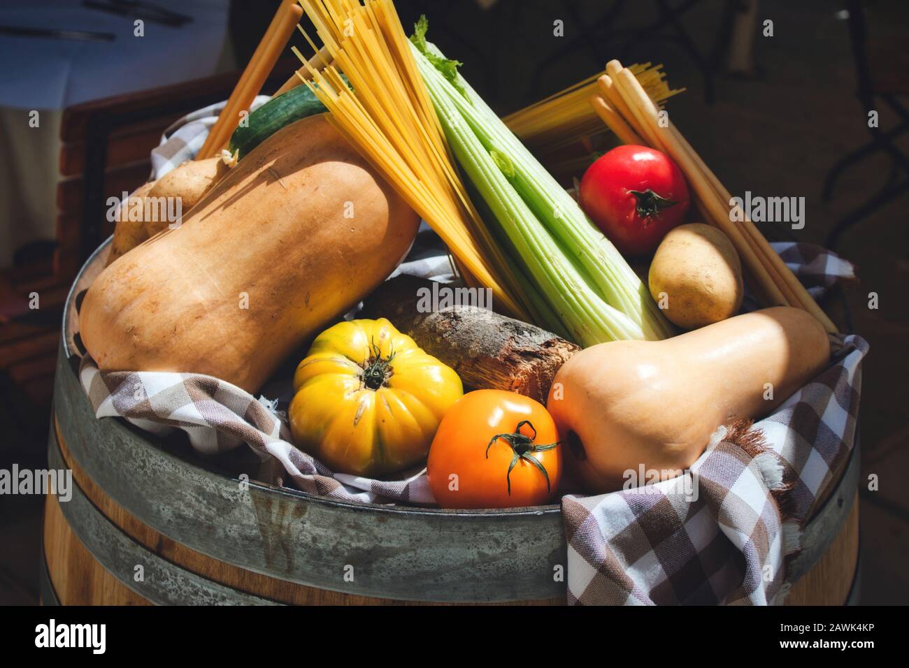 A selection of healthy winter vegetables on display on top of a barrel ...