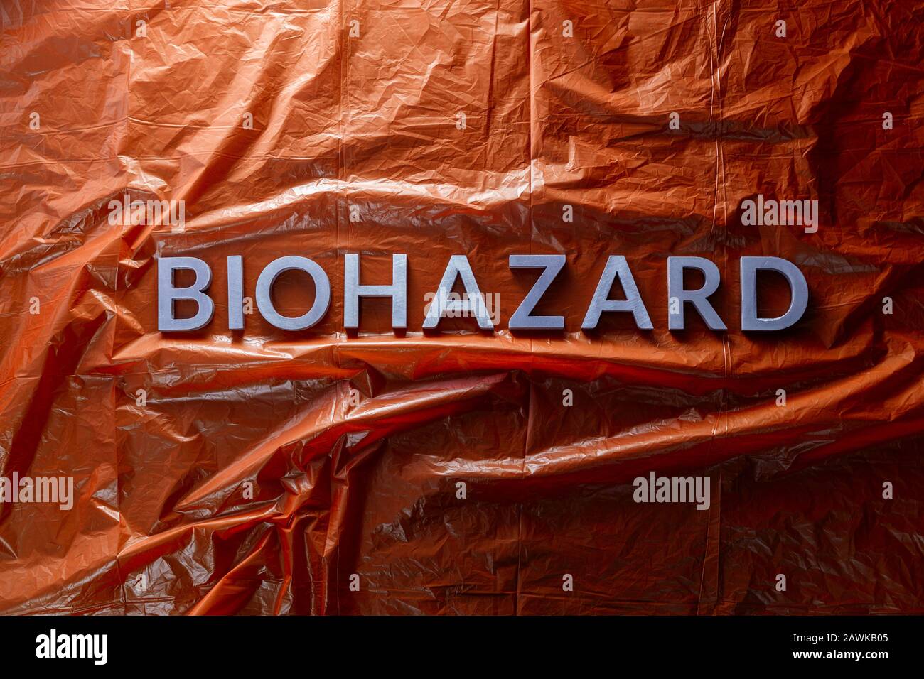the word biohazard laid with silver letters on red crumpled plastic ...